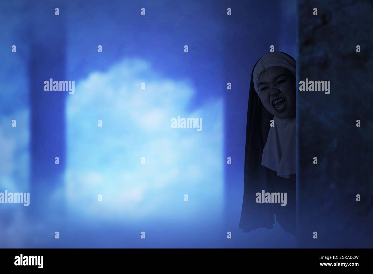 Scary devil nun standing in the abandoned building. Halloween concept ...