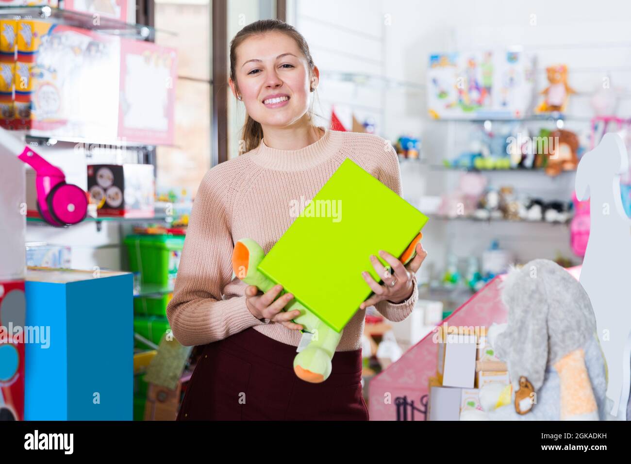 Woman consumer with soft toy Stock Photo - Alamy