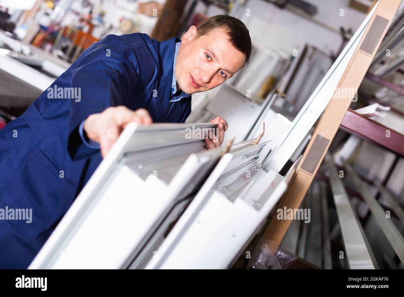 Professional labour with finished PVC profiles and windows at factory ...