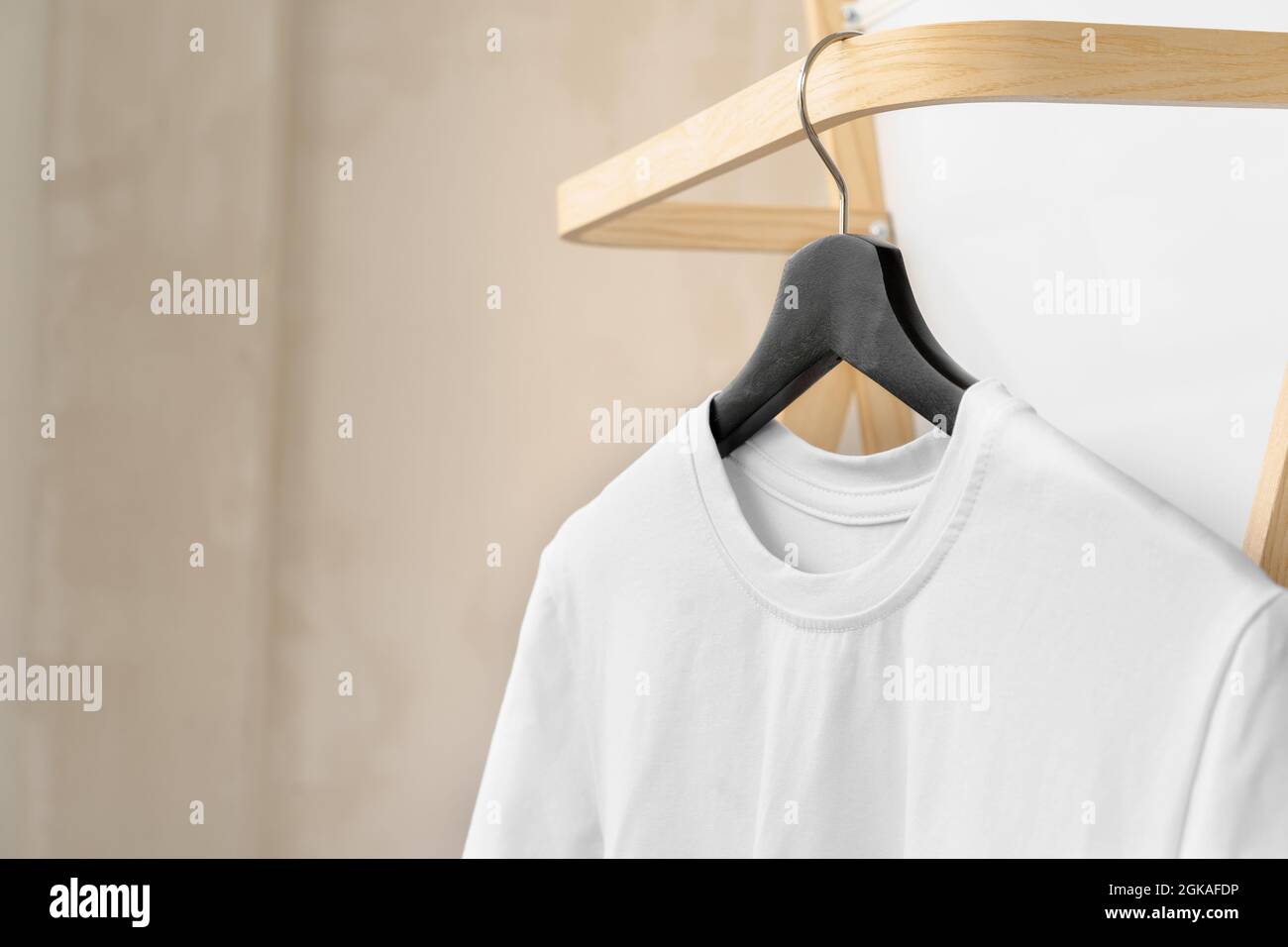 Plain white cotton t-shirt on hanger for your design Stock Photo - Alamy