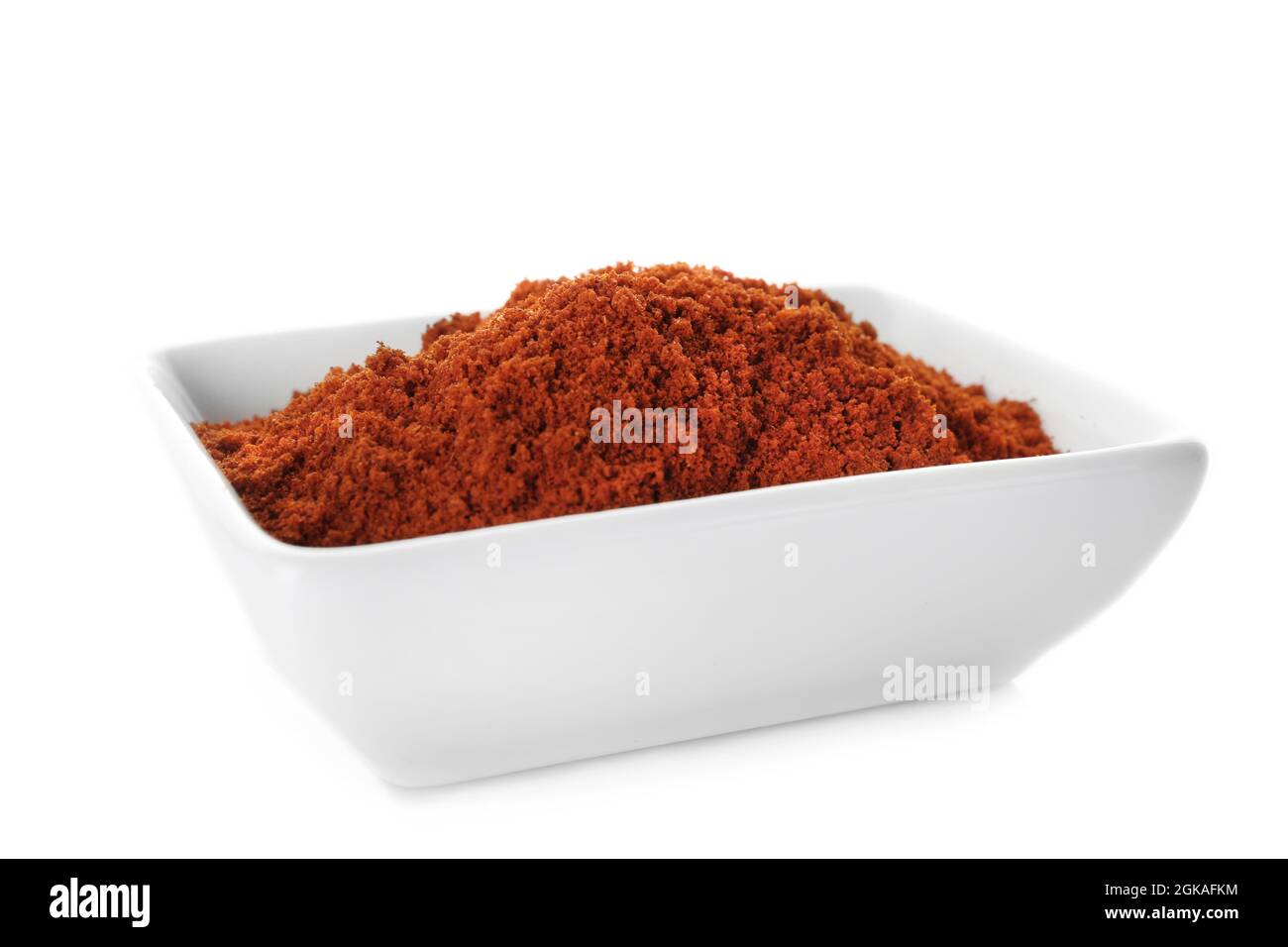 Pile of red chili powder in ceramic bowl isolated on white Stock Photo ...