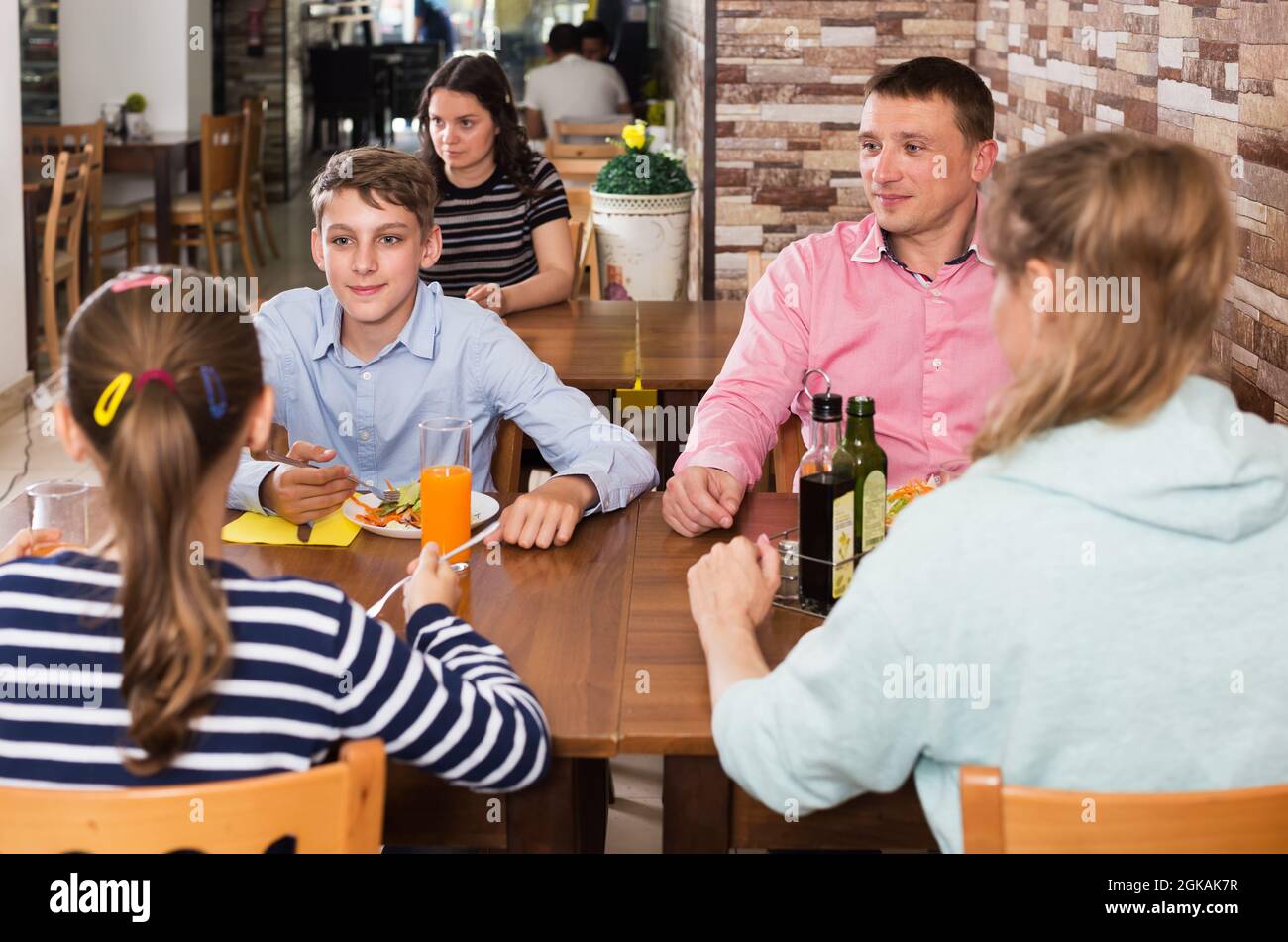 Family dining and talking Stock Photo - Alamy