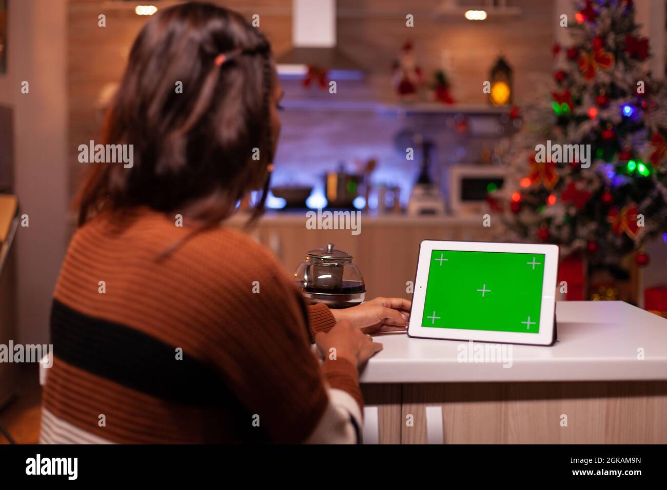 Caucasian adult watching green screen technology on tablet sitting at ...