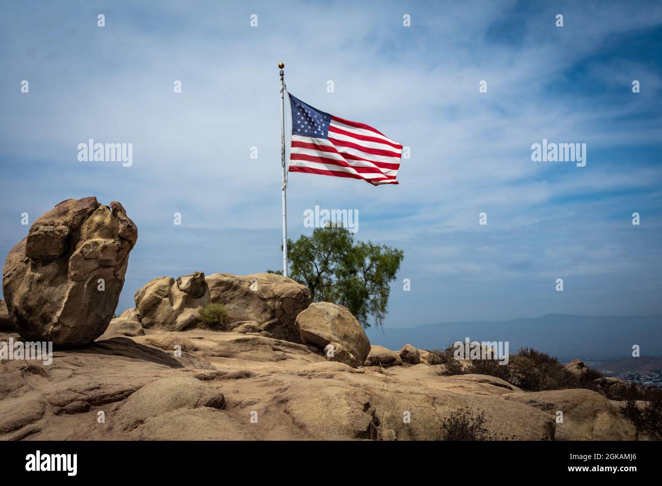 United states of america flag flutter on rock against cloudy sky Stock ...