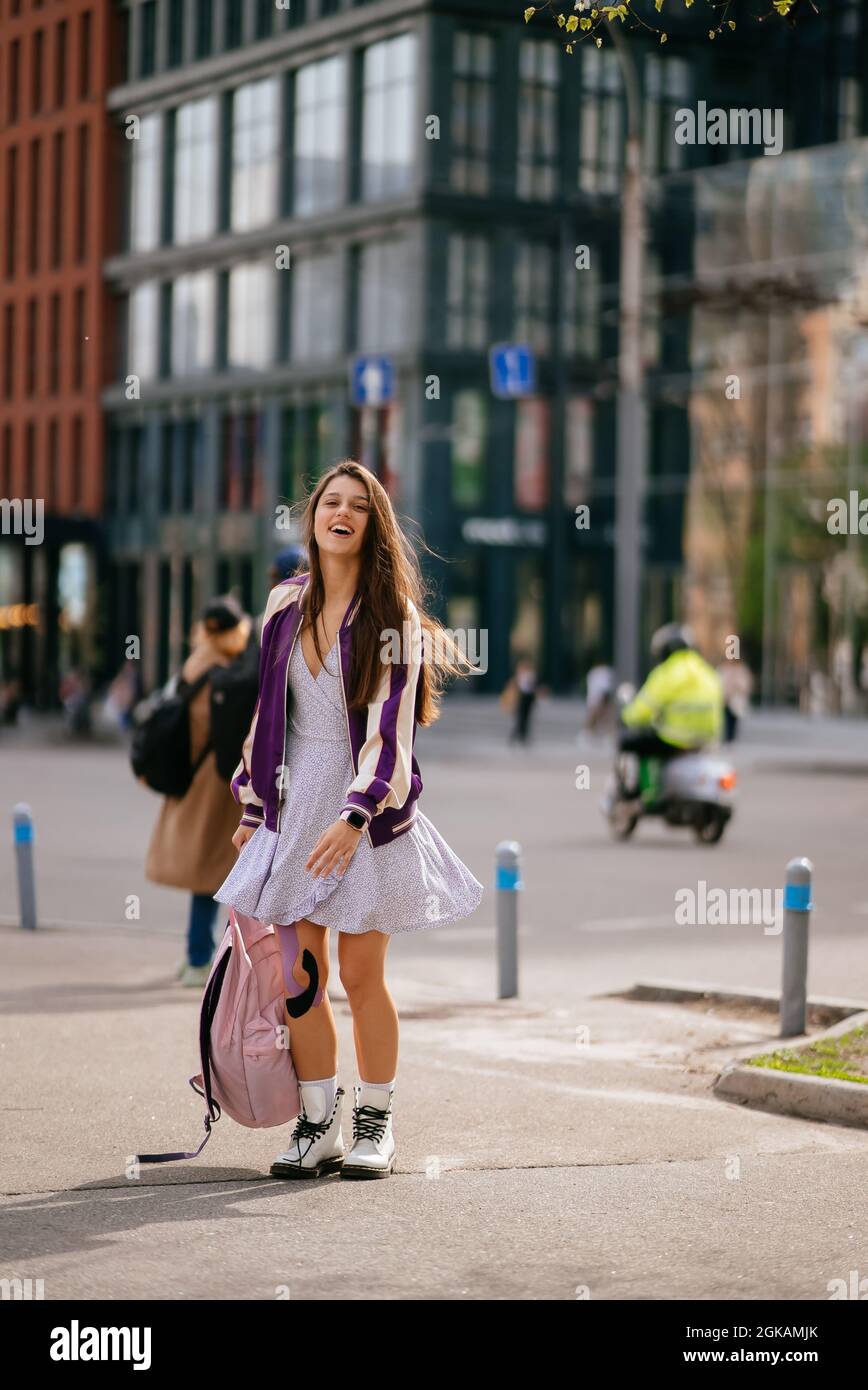 Young beautiful woman with backpack posing at camera Stock Photo - Alamy