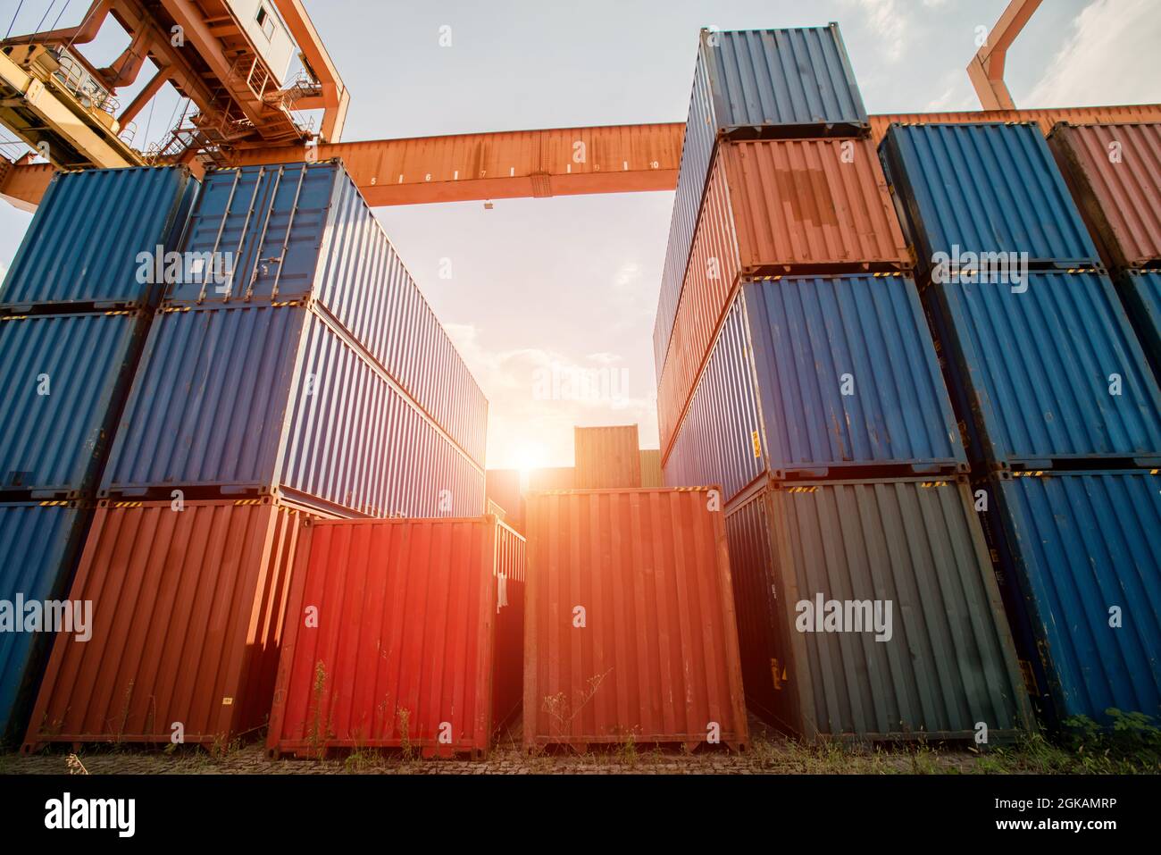 Sun shining over a container yard and crane at a port Stock Photo - Alamy