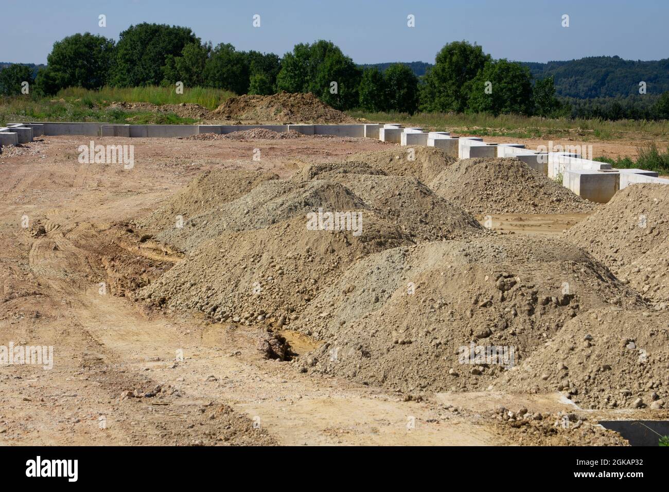 some piles of sand on a construction site to built a ground of a ...