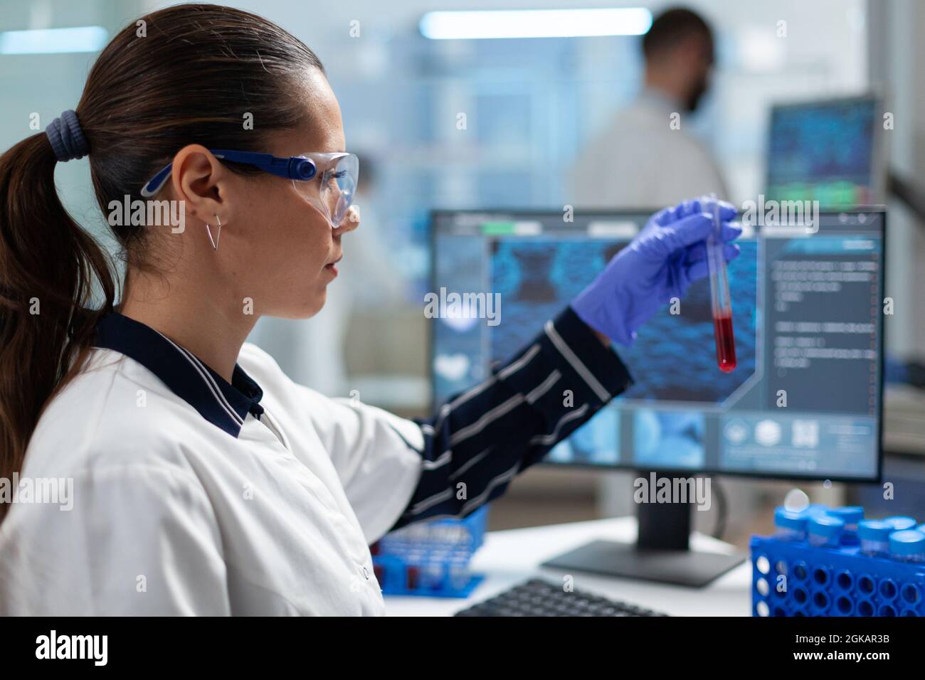 Biologist researcher holding blood test tube analyzing dna medical ...