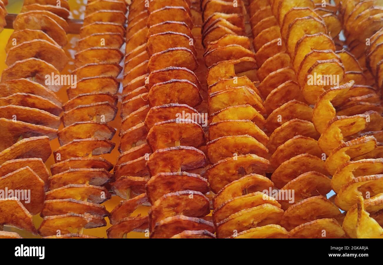 Round twisted potato fry with stick.Crispy Potato Fry Stock Photo - Alamy