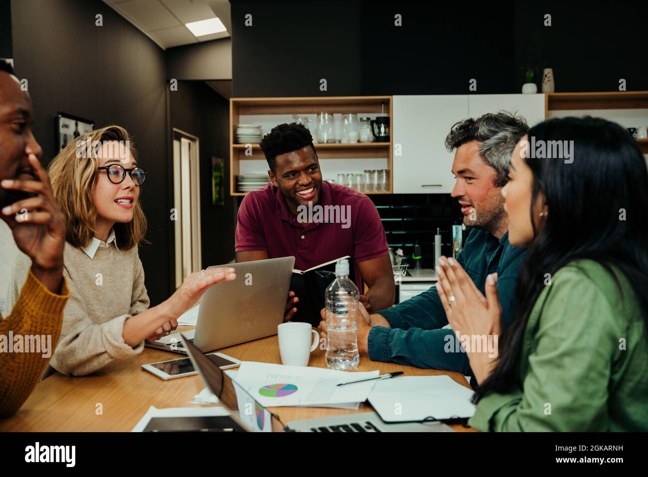 Team meeting during lunch break in office lounge briefing before big ...