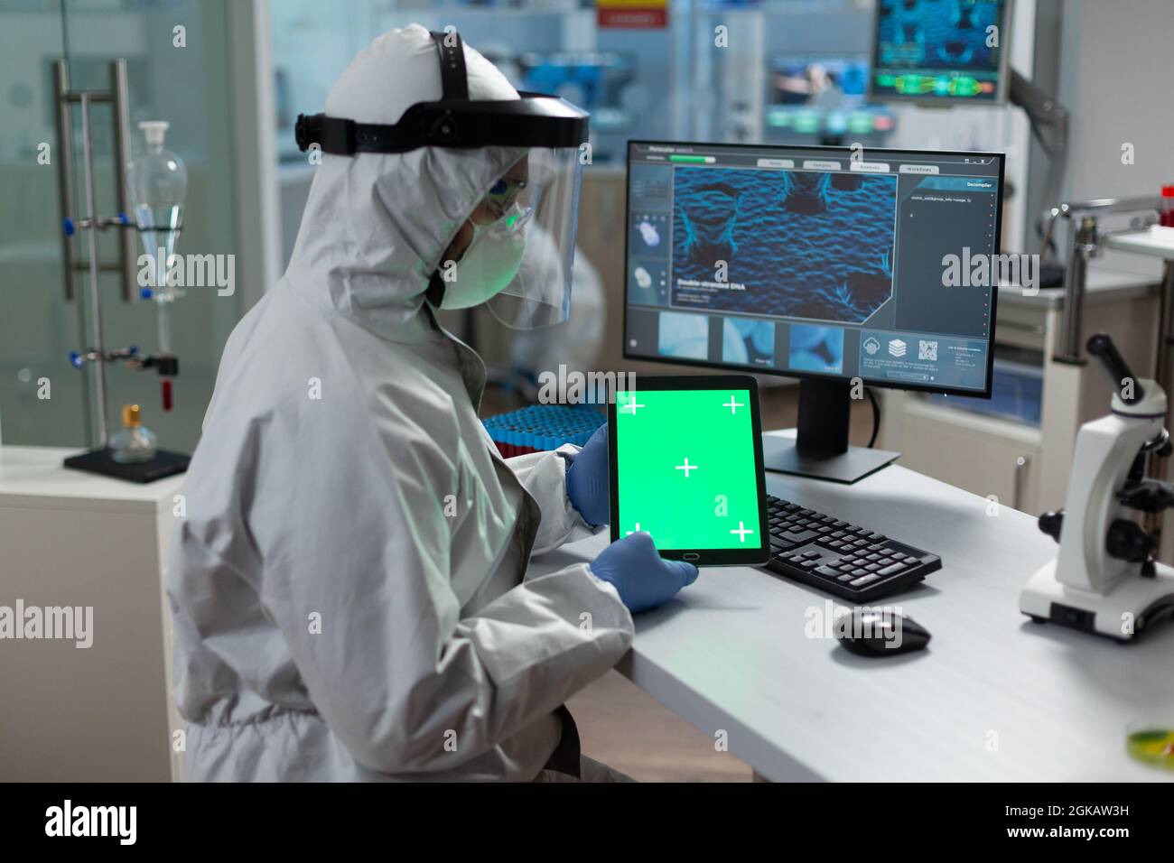 Biologist researcher holding mock up green screen chroma key tablet ...
