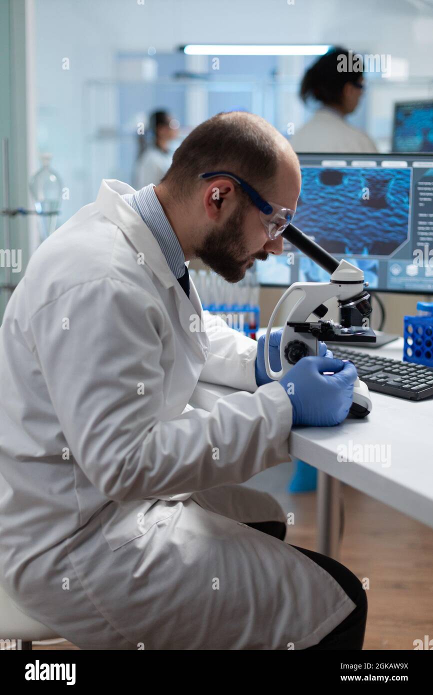 Biologist scientist man doctor examining coronavirus sample results ...