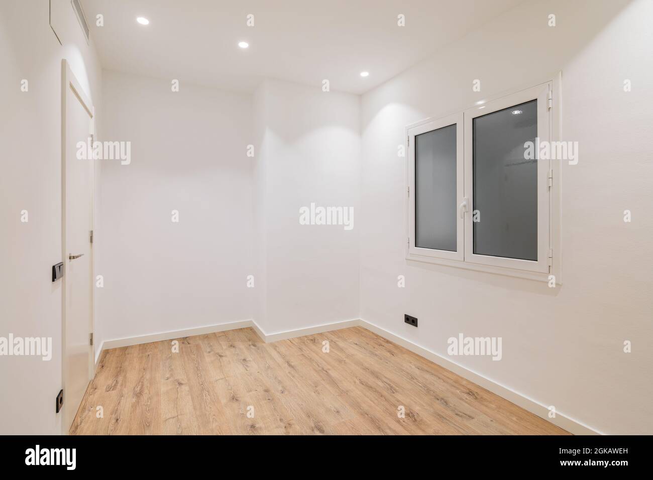 Empty clean room after renovation with white walls, window and wooden ...