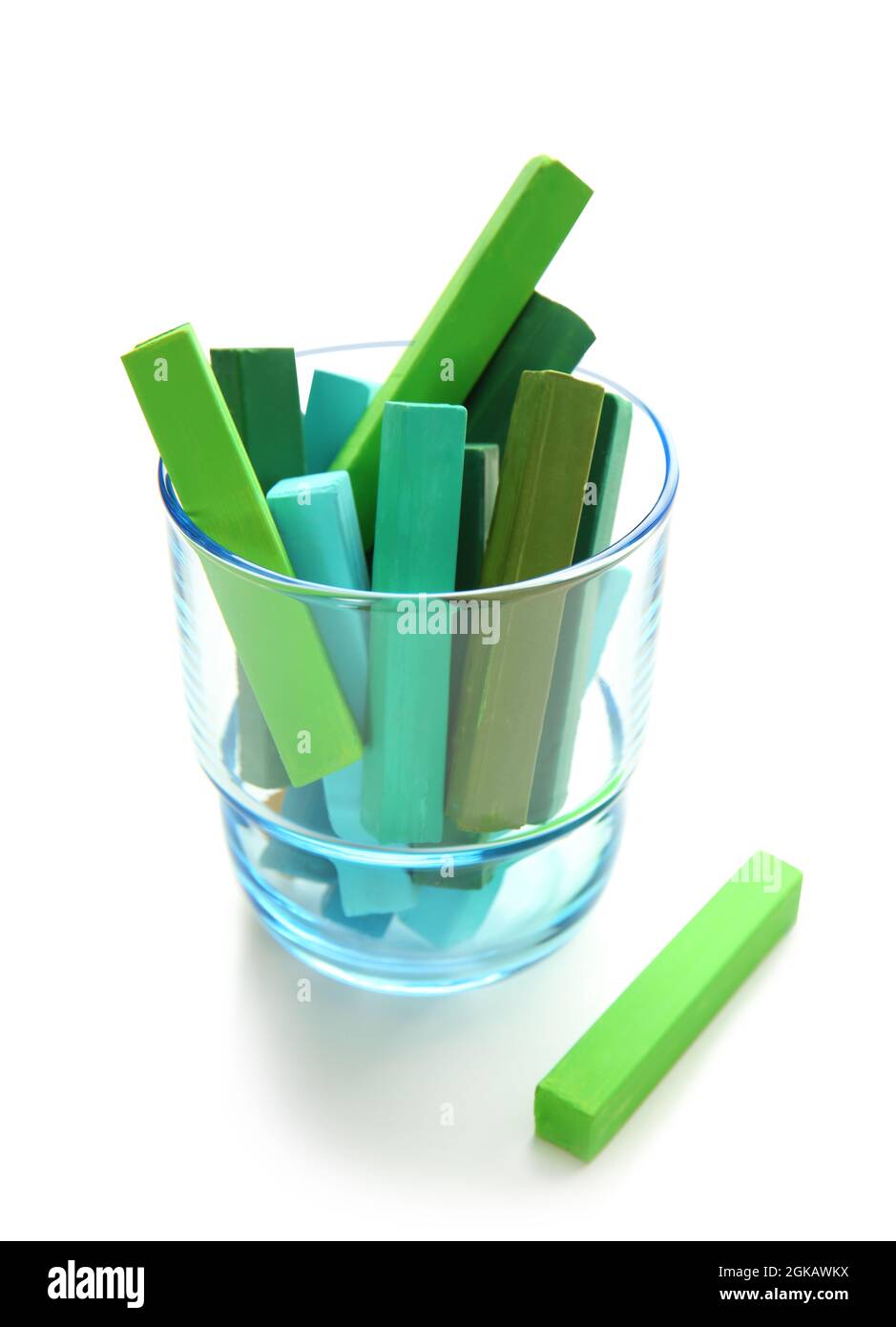 Bright green chalk in glass on white background Stock Photo - Alamy