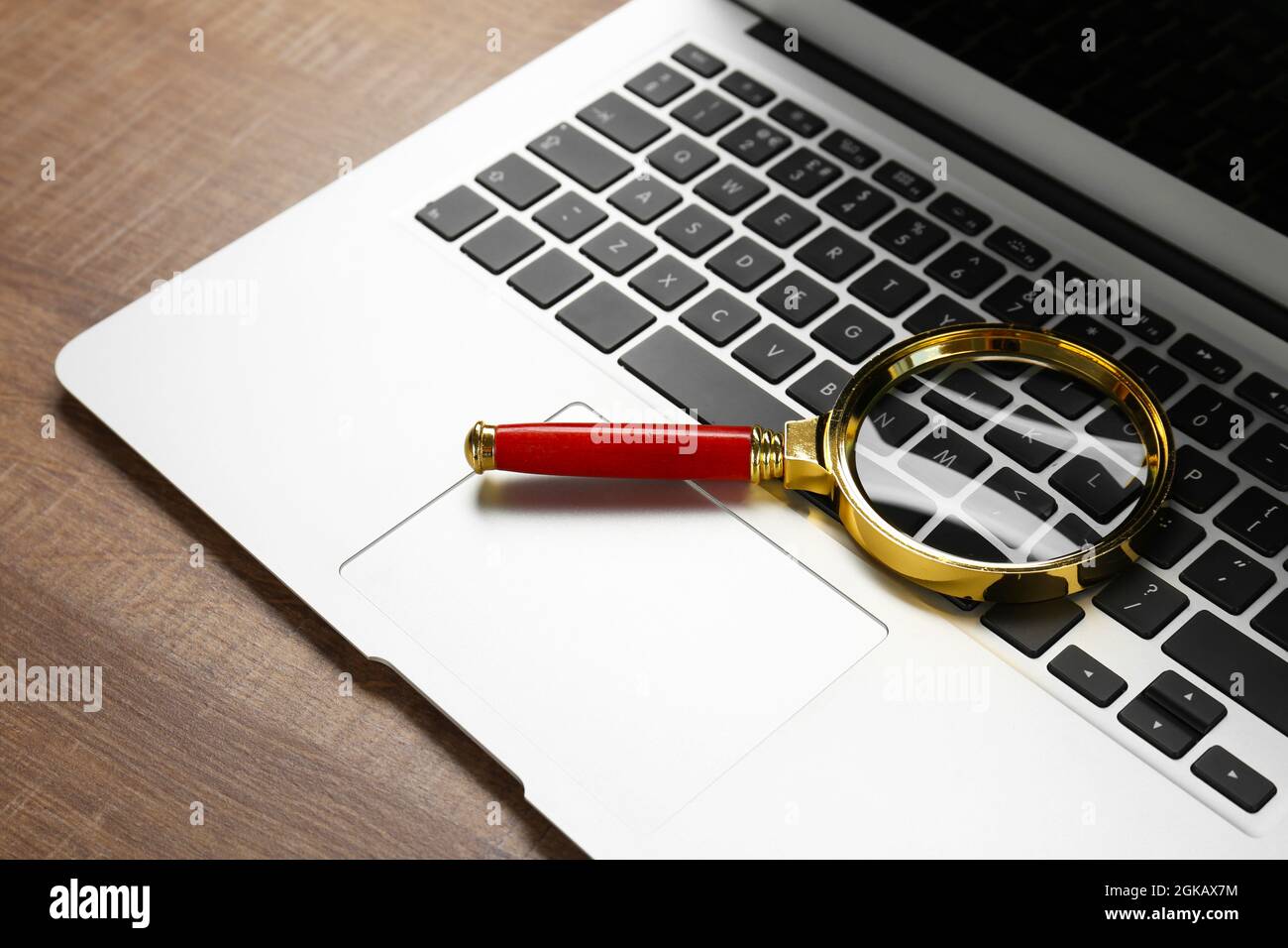 Magnifying glass on laptop. Internet search concept Stock Photo - Alamy