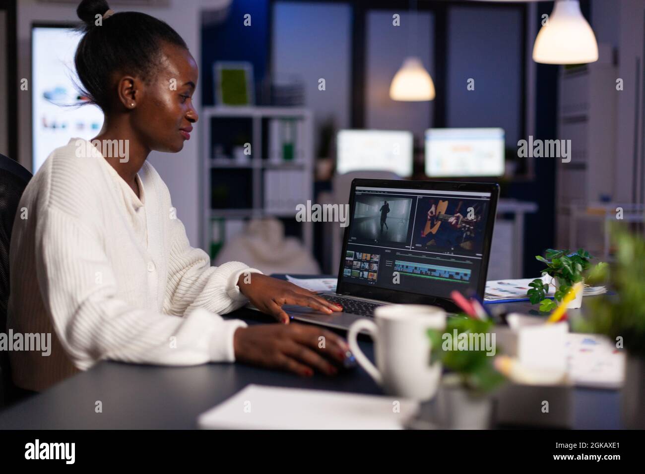 African american video editor working late at night at digital movie ...