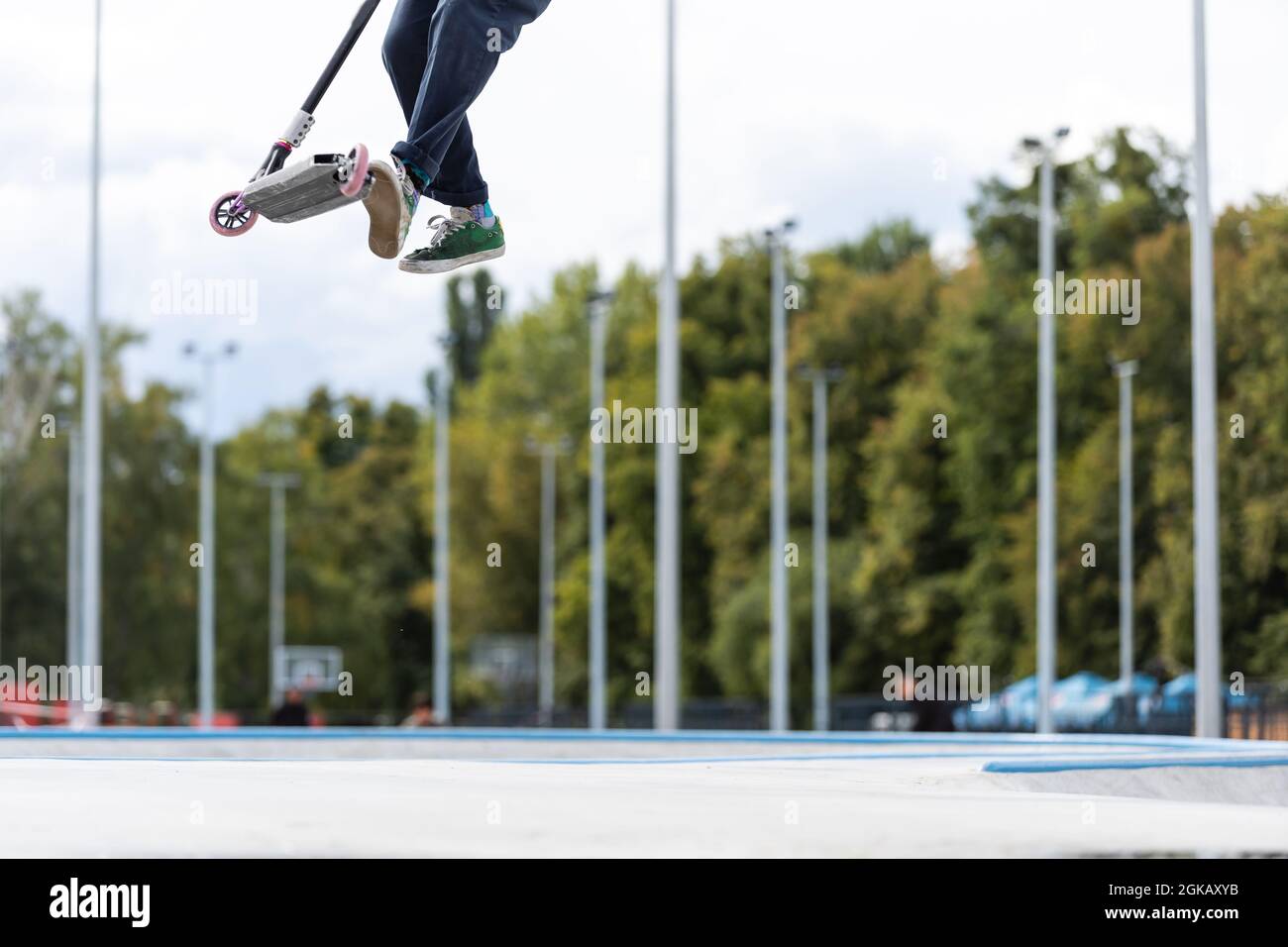 boy jumping with his scooter, scooter stunt Stock Photo - Alamy