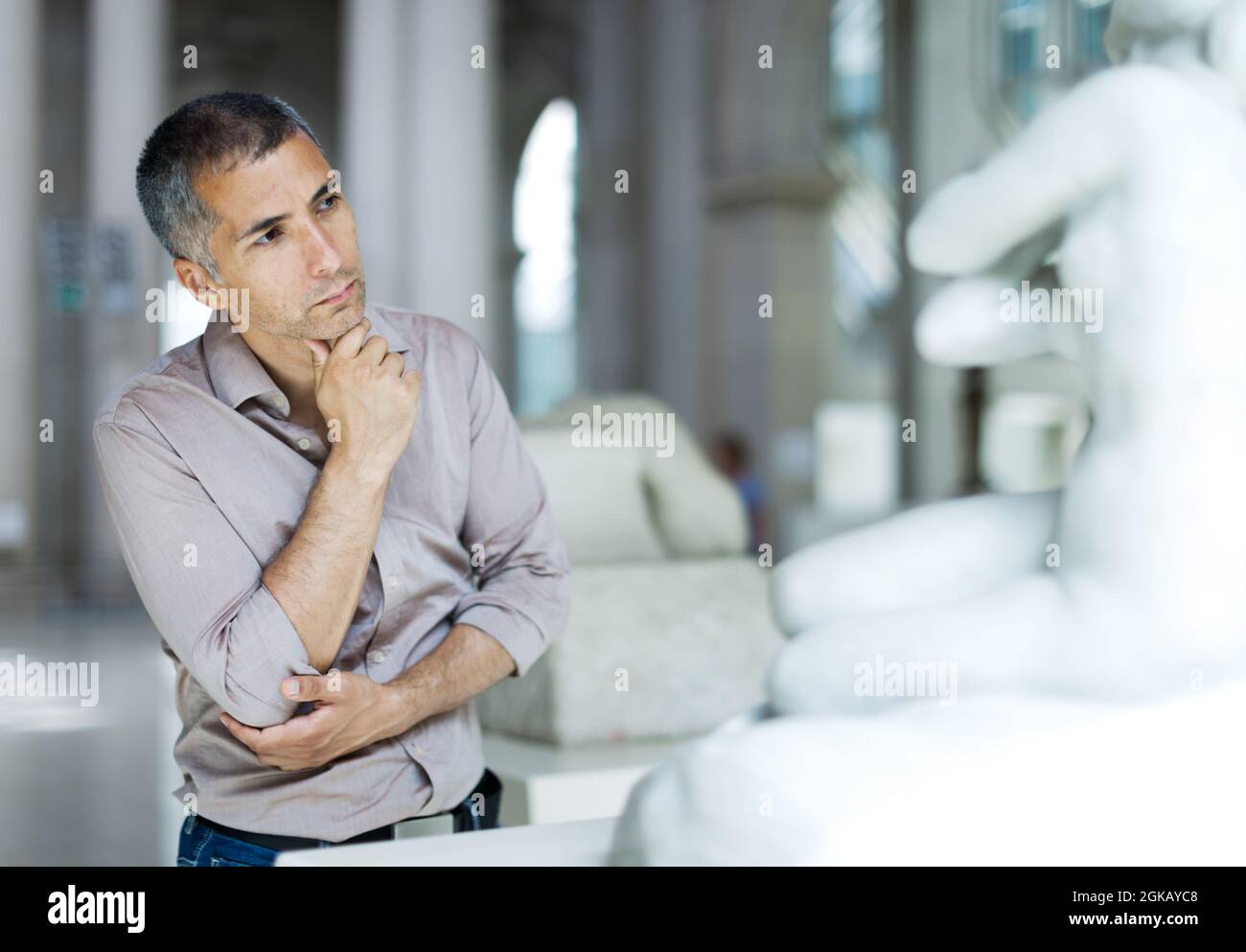 Adult man is visiting museum and looking at the exposition Stock Photo ...