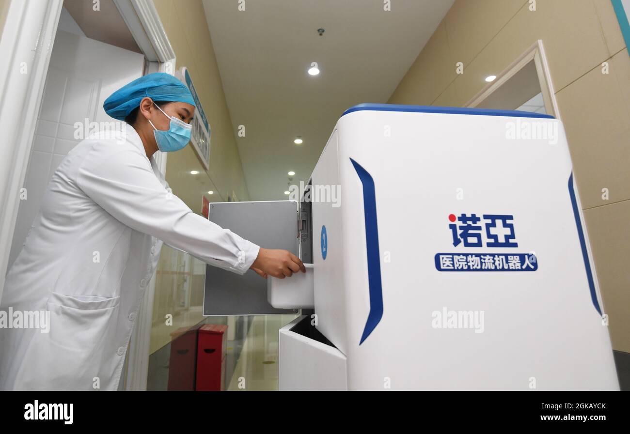 GUIYANG, CHINA - SEPTEMBER 14, 2021 - A pharmacist loads medicines into ...