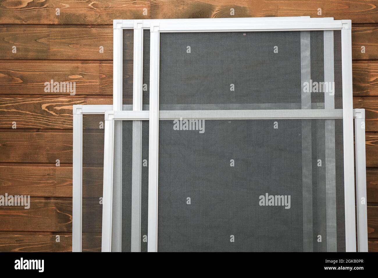 Mosquito window screens on wooden background Stock Photo - Alamy