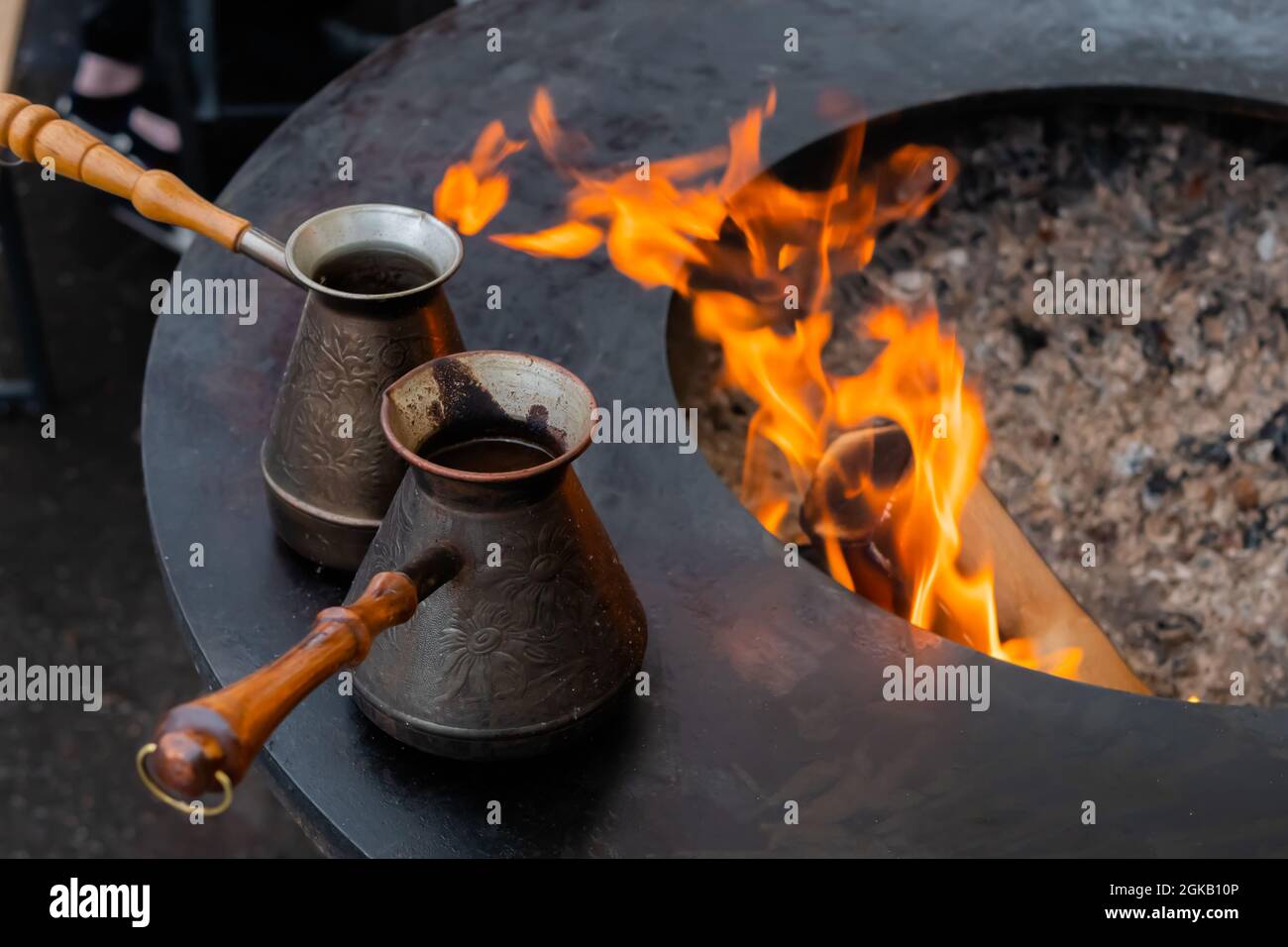 Preparing Turkish coffee with black cezve or ibrik at street food ...