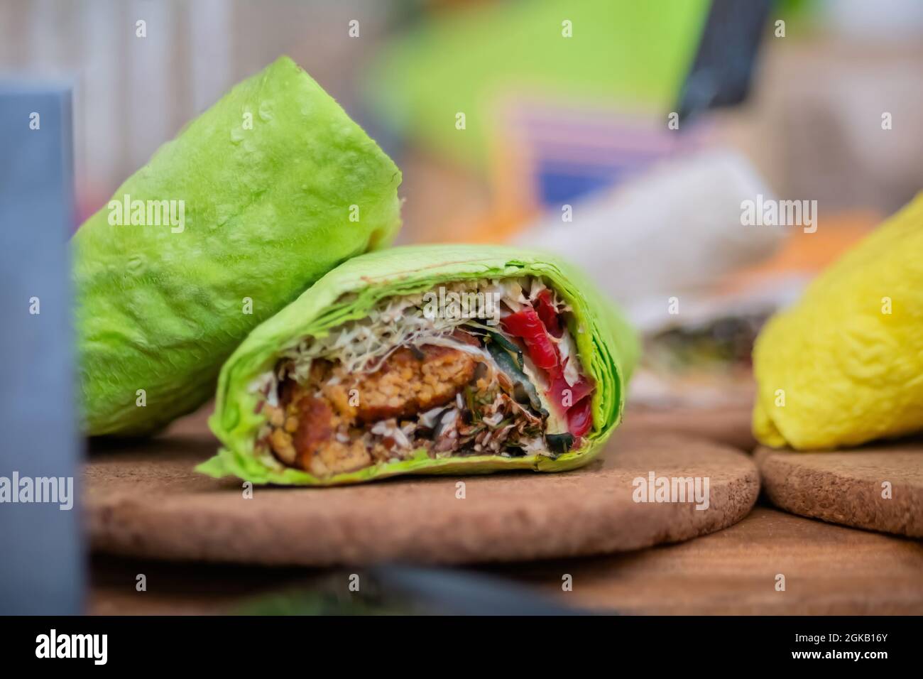 Fresh colorful vegan doner rolls with vegetables on counter at summer ...