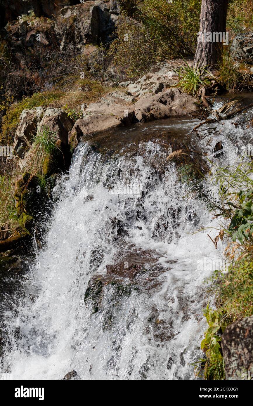 Close-up of a powerful waterfall in high quality. Side view of a sun ...