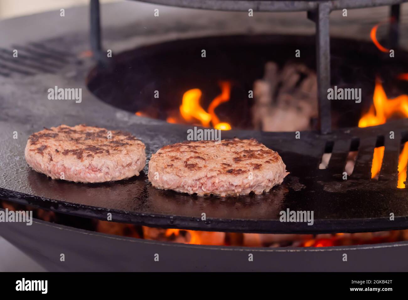 Process of grilling cutlets for burgers on brazier with hot flame Stock ...