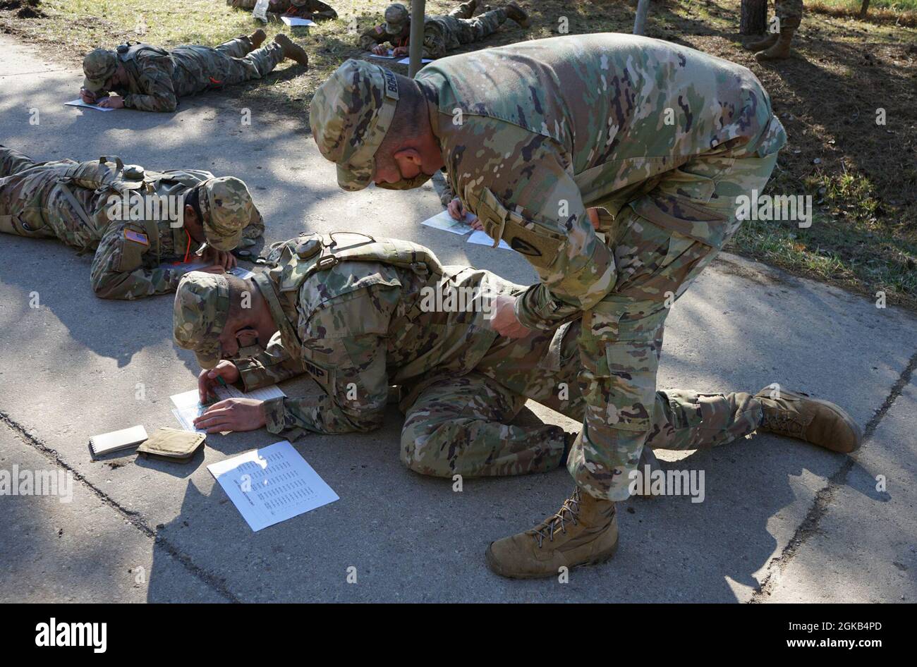 Command Sgt. Maj. Eric Bohannon watches as Sgt. David Baker, both from ...