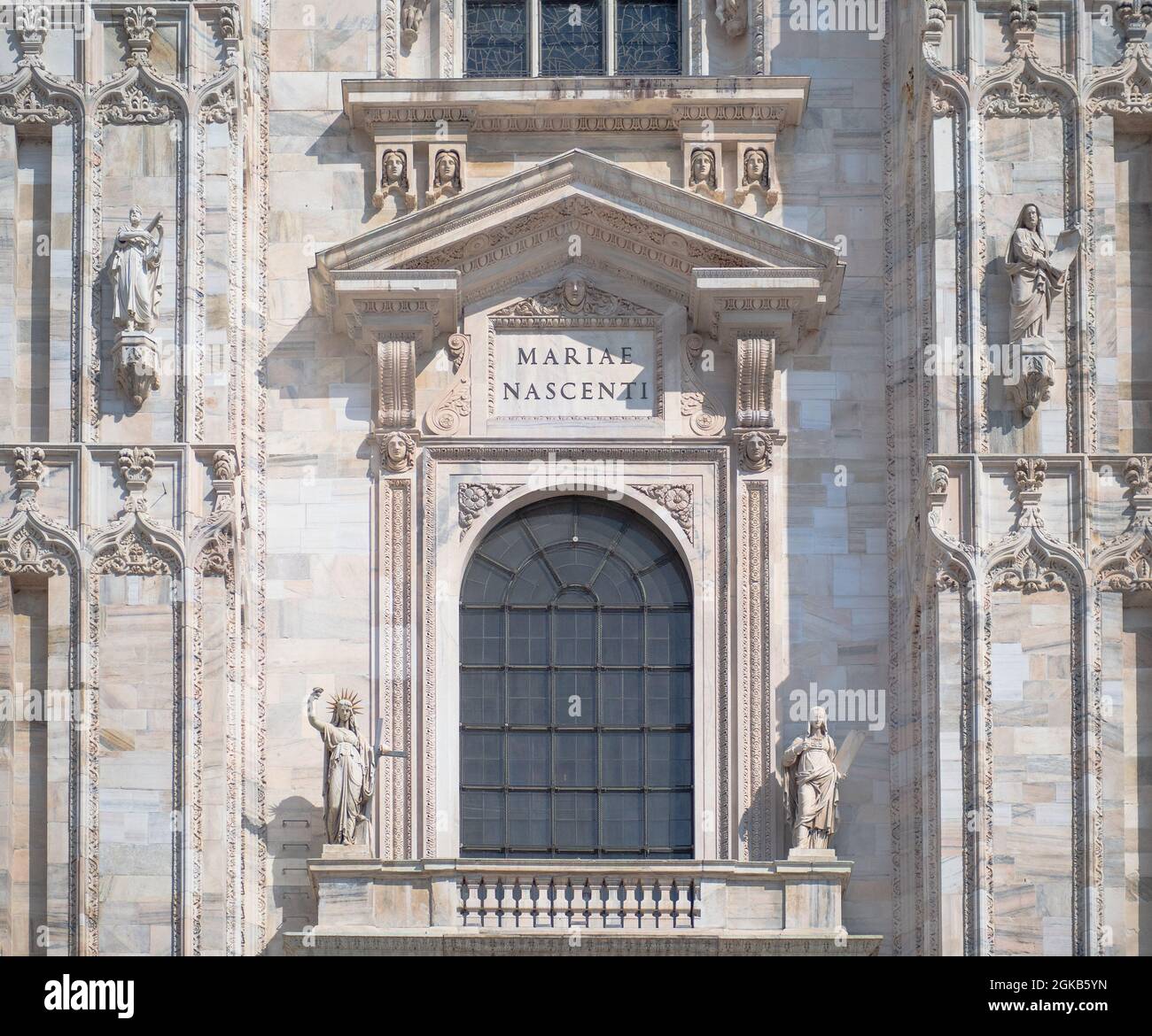 marble statues and artistic decorations on the facade of the Duomo ...