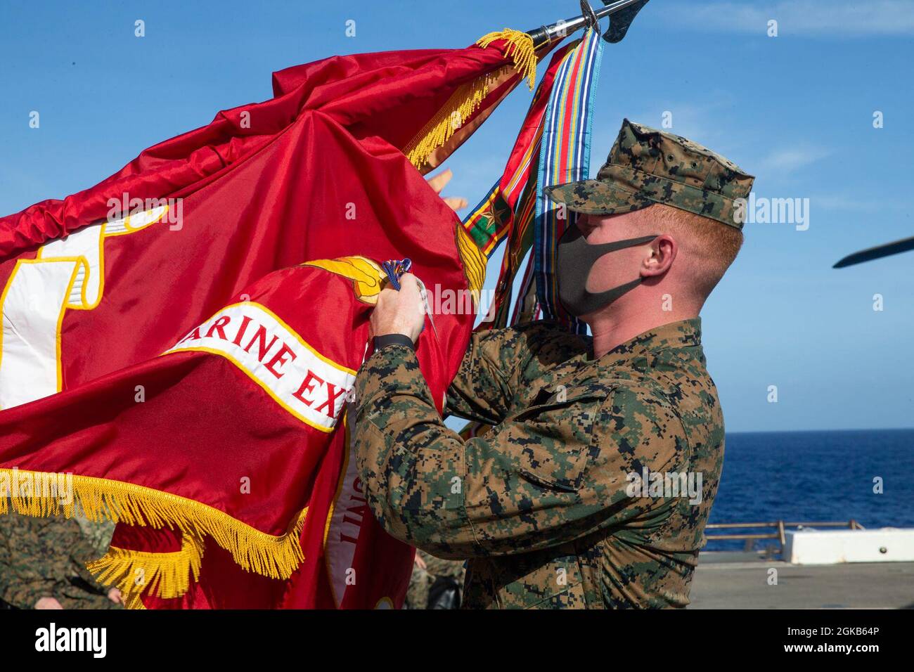 A U.S. Marine adds a streamer to the 31st Marine Expeditionary Unit ...