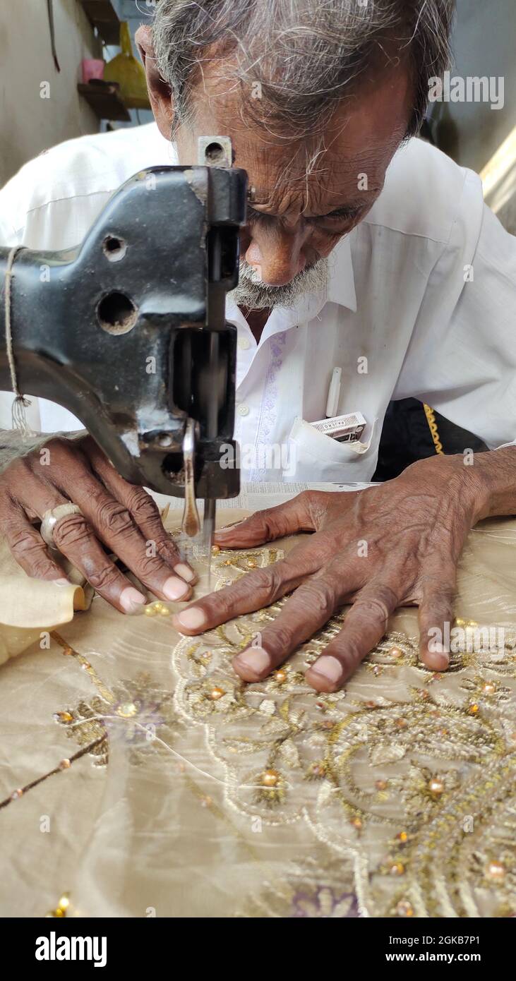 hands of old men working in sewing machine. embroidery machine ladies ...