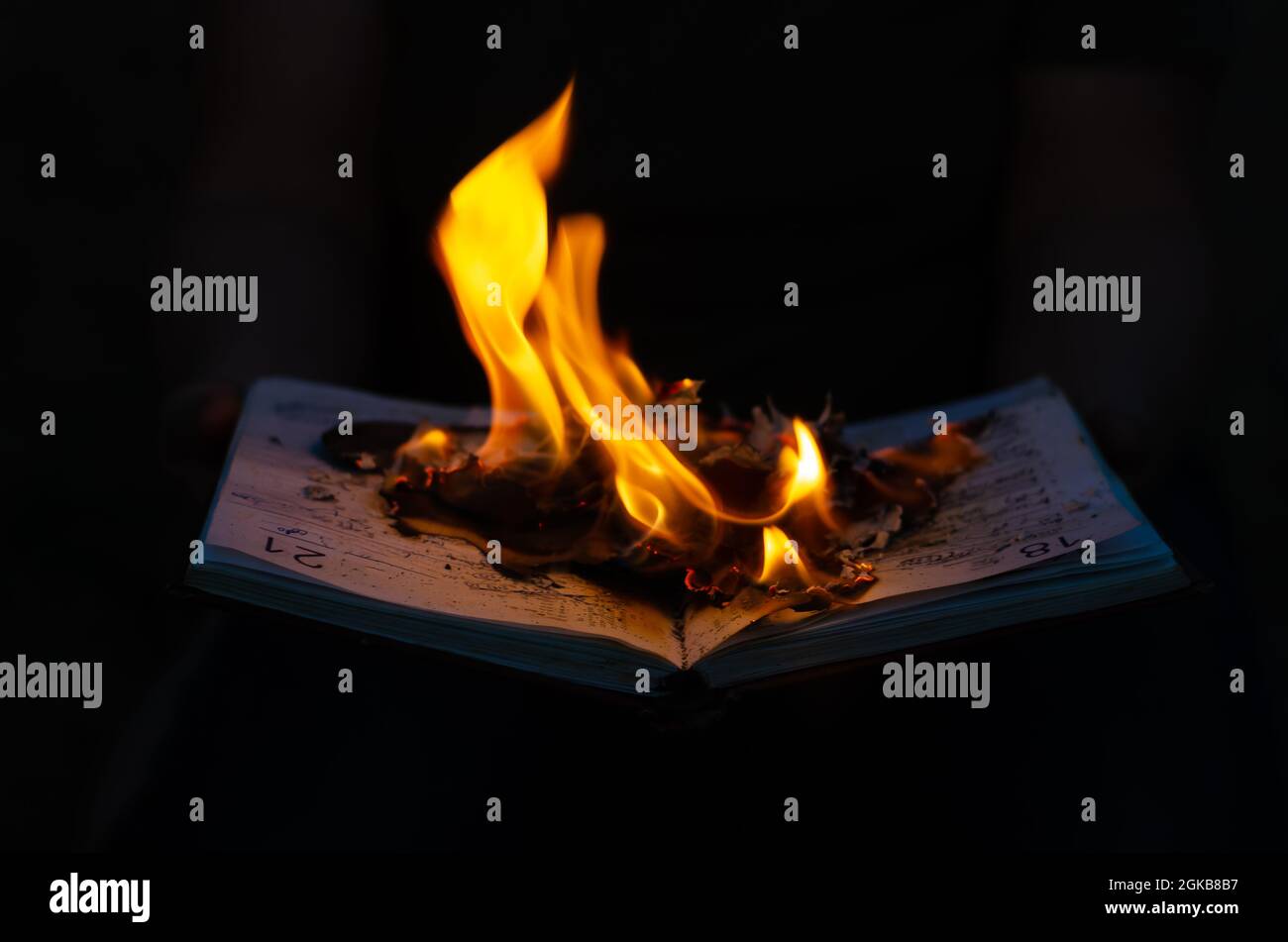 Open burning diary on black background. Notebook with flame cove Stock ...
