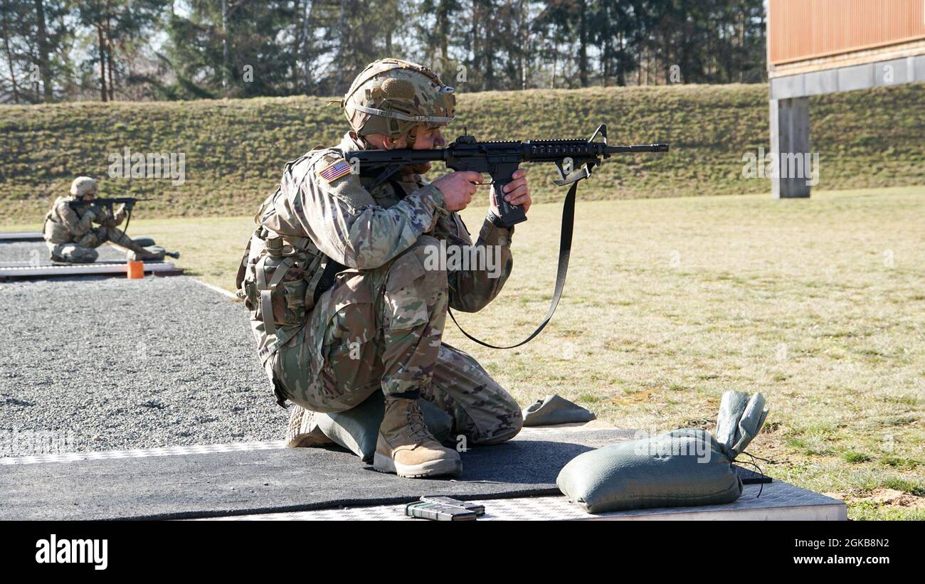 Sgt. David Baker, USAG Ansbach, shoots his weapon down range at ...