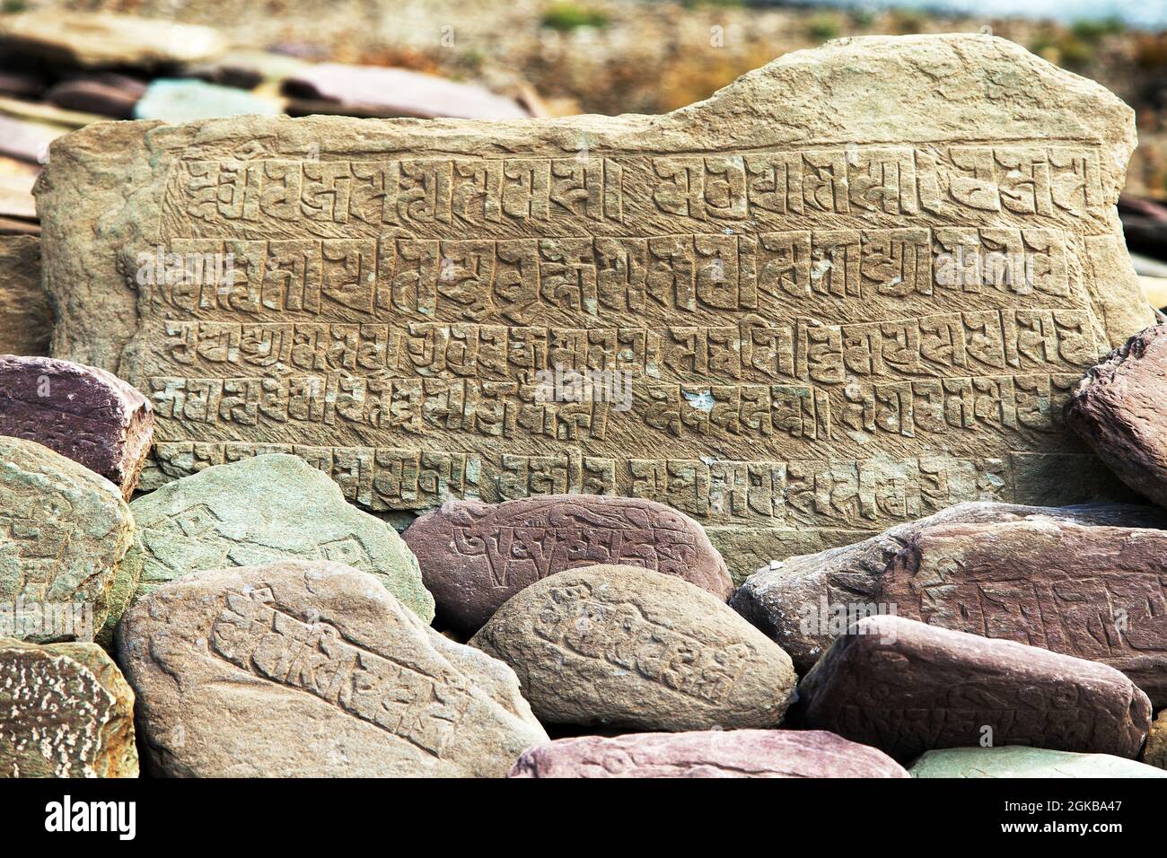 Mani wall and stones with buddhist symbols Stock Photo - Alamy