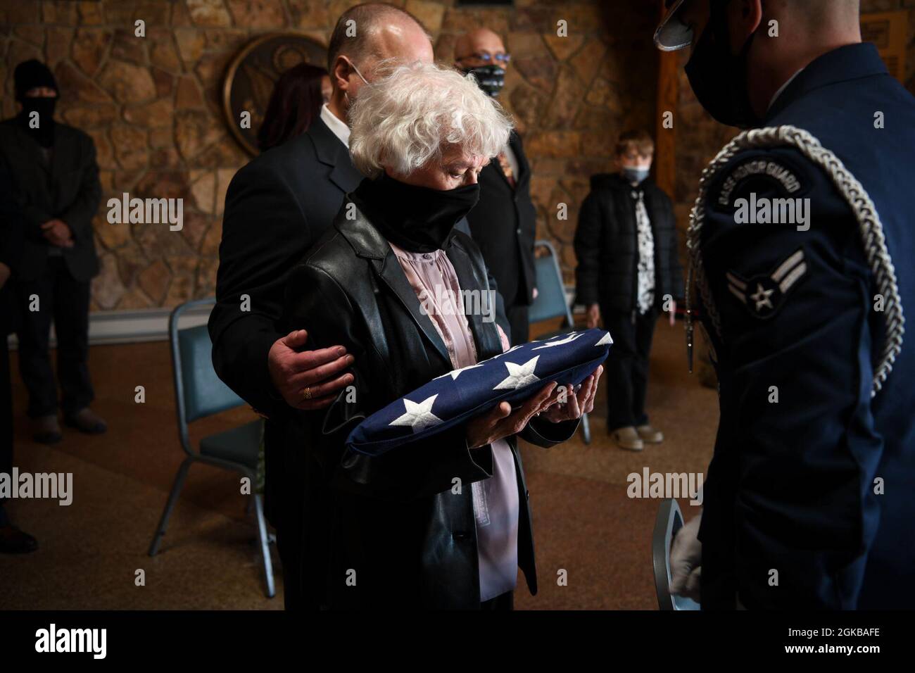 The wife of Maj. LaVerne R. Tech receives a folded American flag at her ...