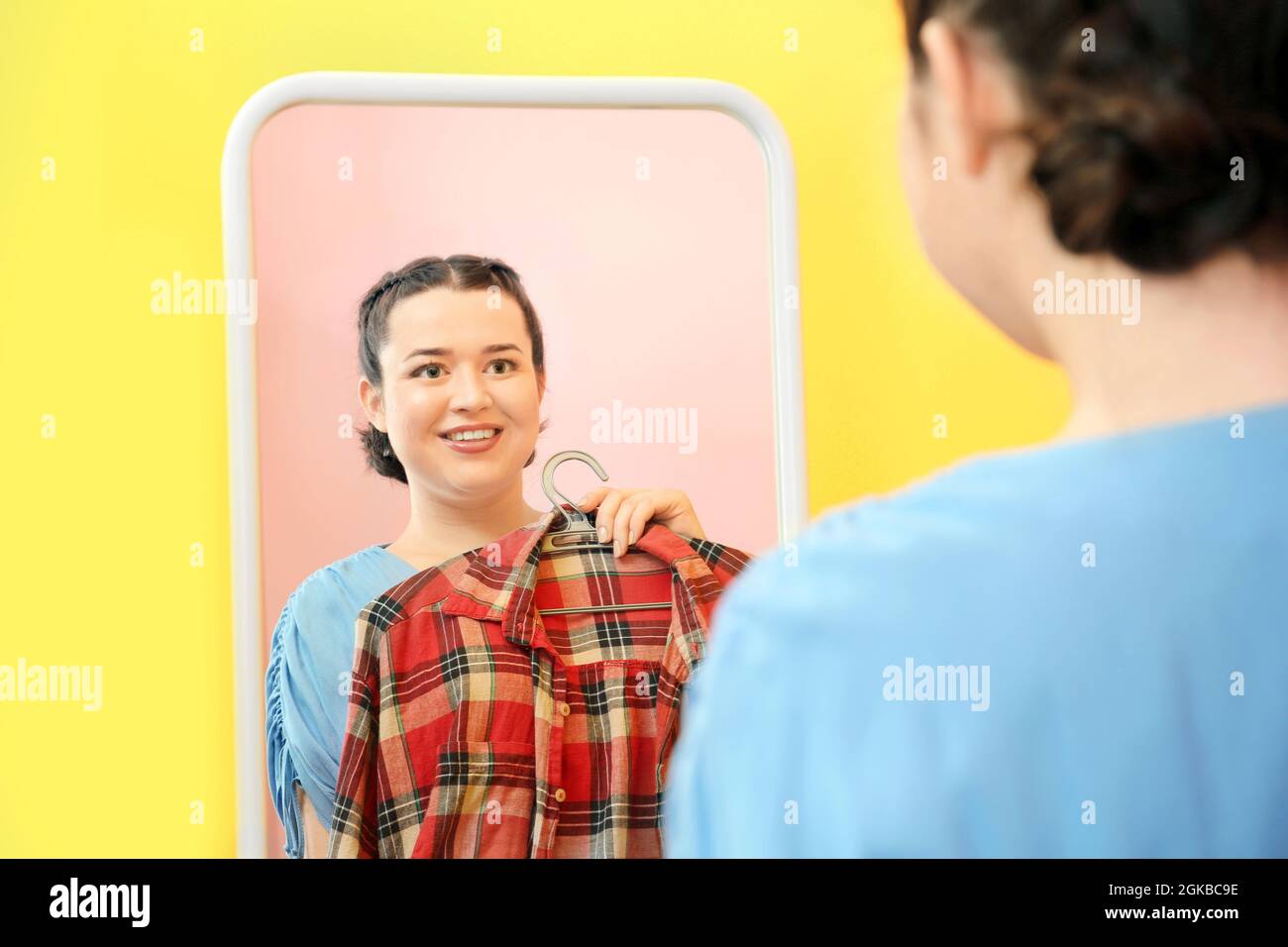 Beautiful overweight woman standing near mirror at store Stock Photo ... Beautiful overweight woman standing near mirror at store Stock Photo ...