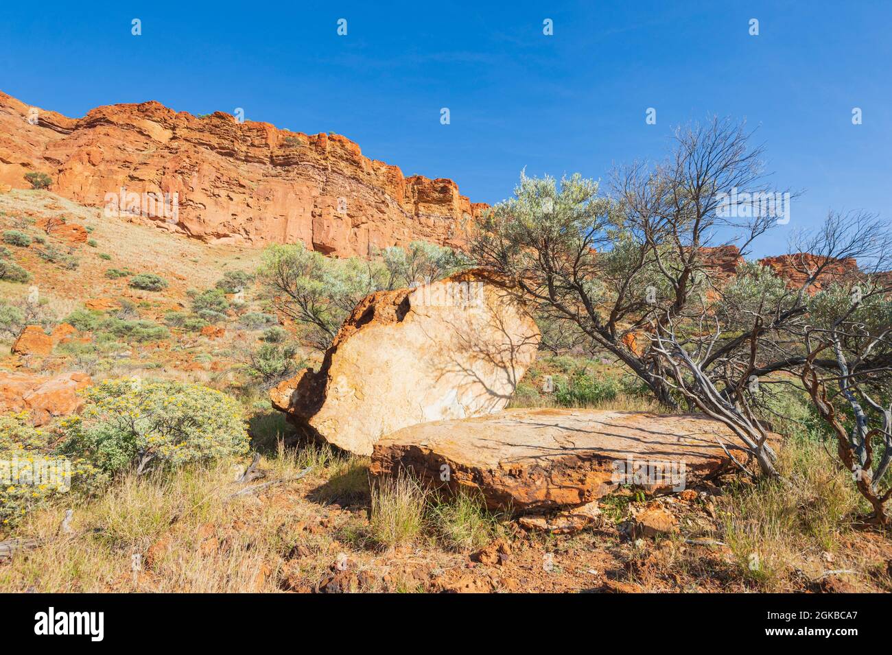 View of an eroded split red sandstone boulder in Kennedy Range National ...
