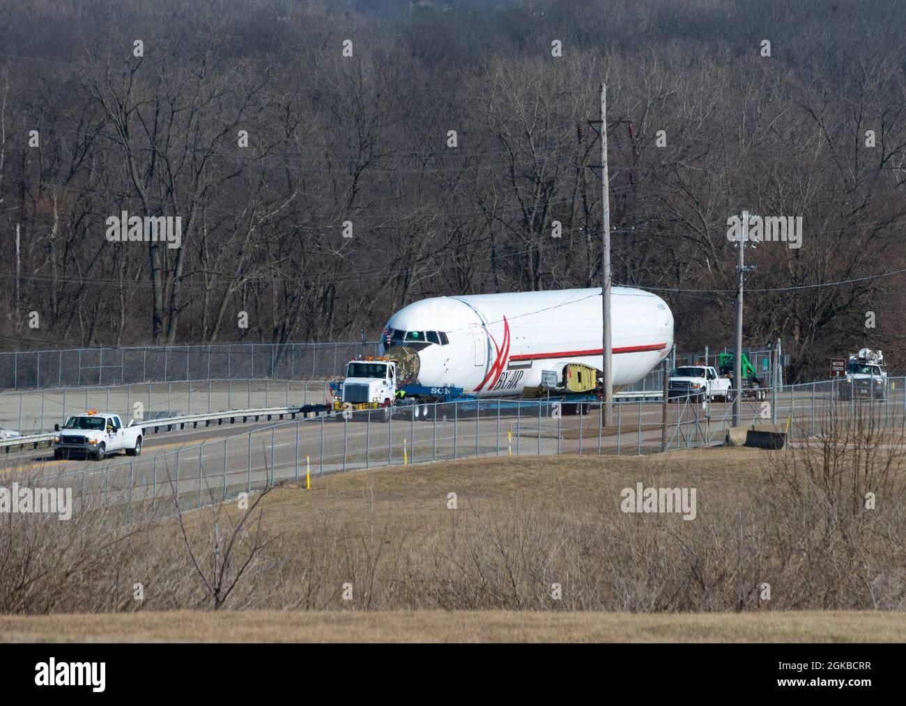 The fuselage of a Boeing 767 is towed up a hill as it approaches Wright ...