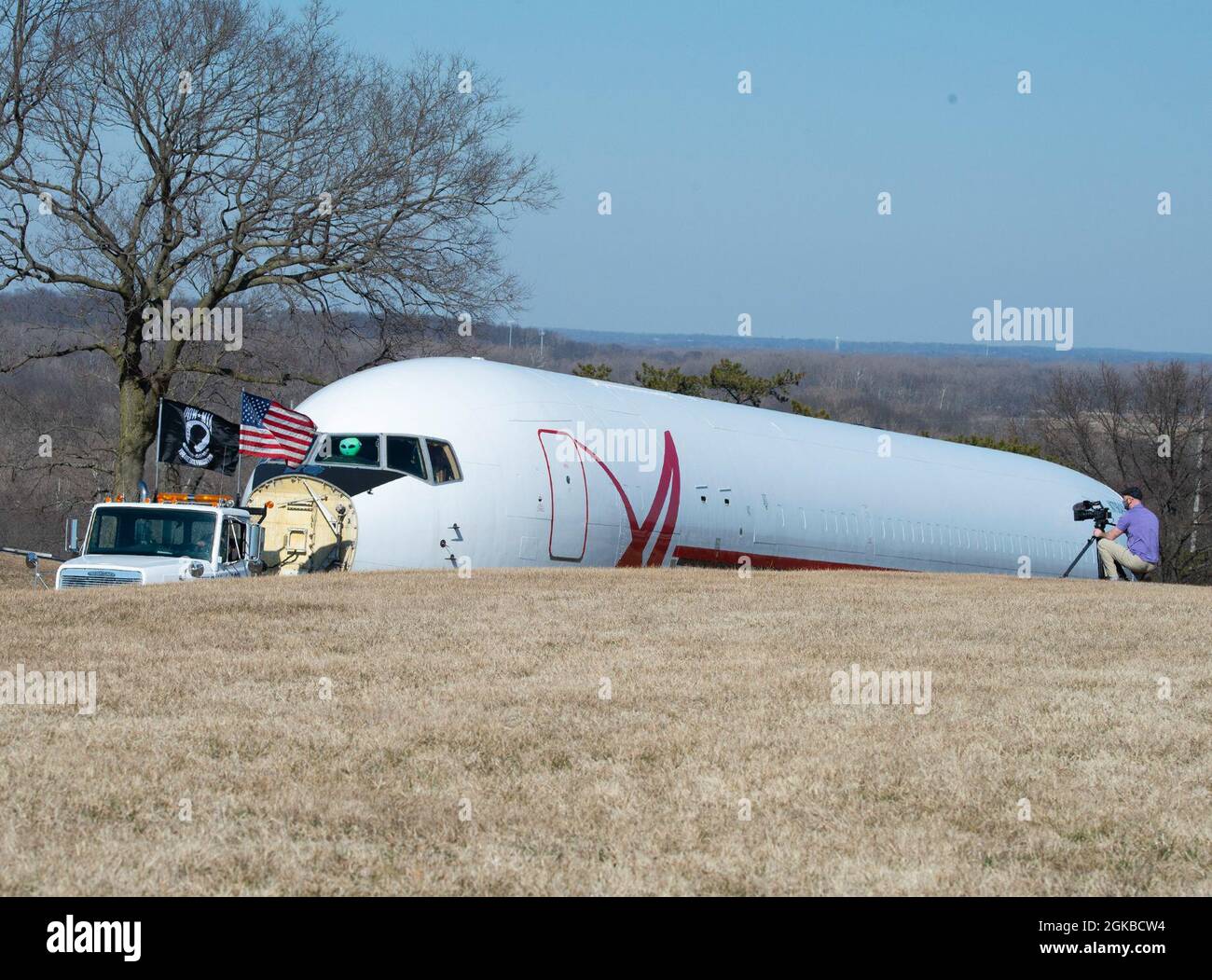 A truck pulls the fuselage of a Boeing 767 up a hill on March 3, 2021 ...