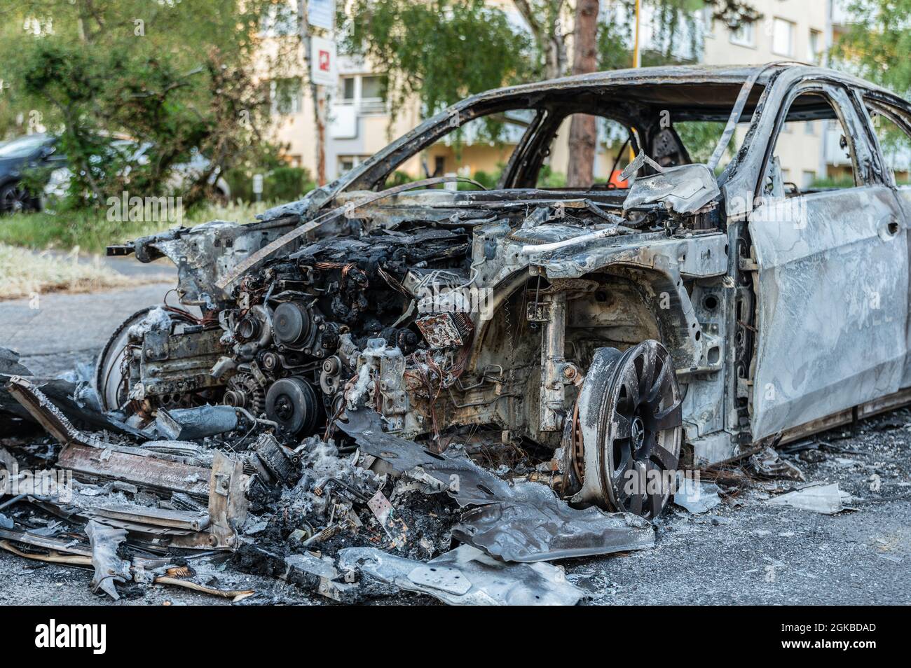 Burnt out Mercedes in the residential area by the roadside. Front right ...