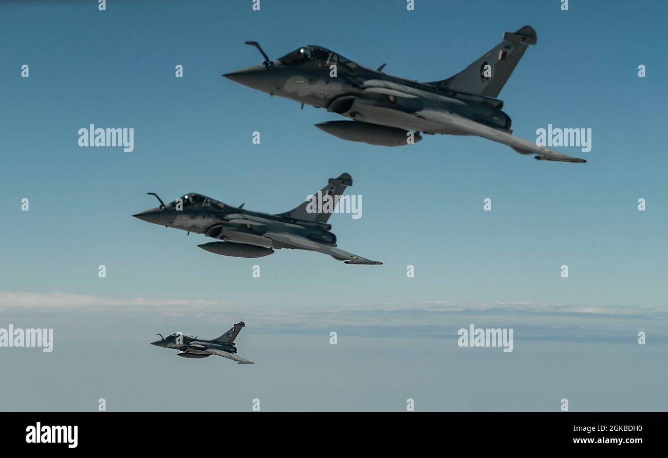 Three Qatar Emiri Air Force Rafale aircraft fly alongside a U.S. Air ...