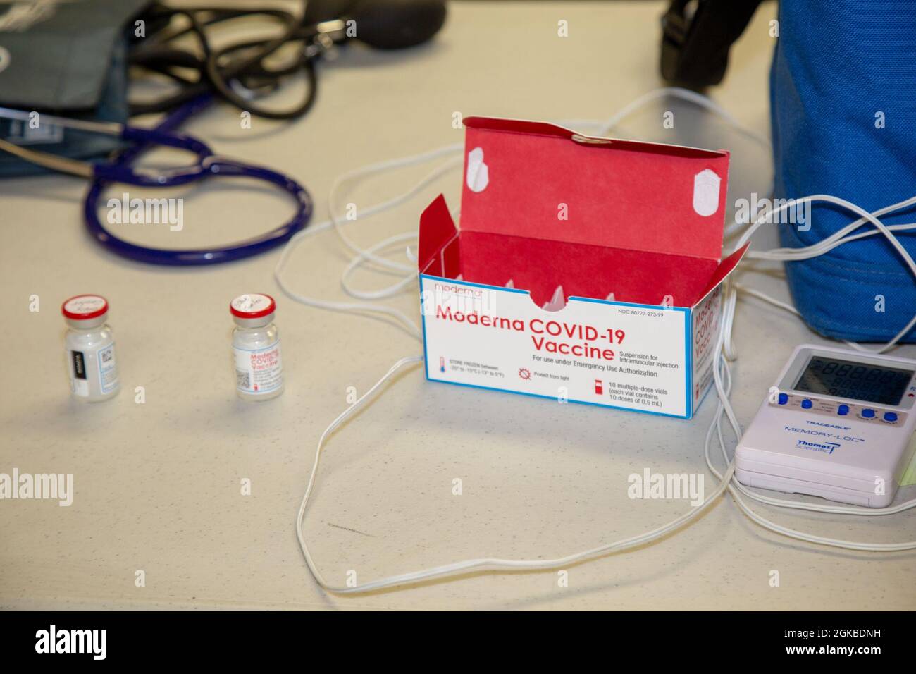 The Moderna version of the COVID-19 vaccination being administered ...
