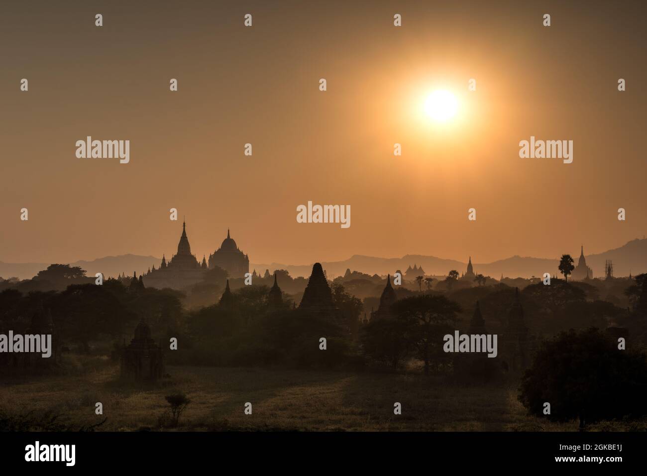 Sunset over Shwegu Gyi Phaya Temple and Thatbyinnyu Phaya Temple ...