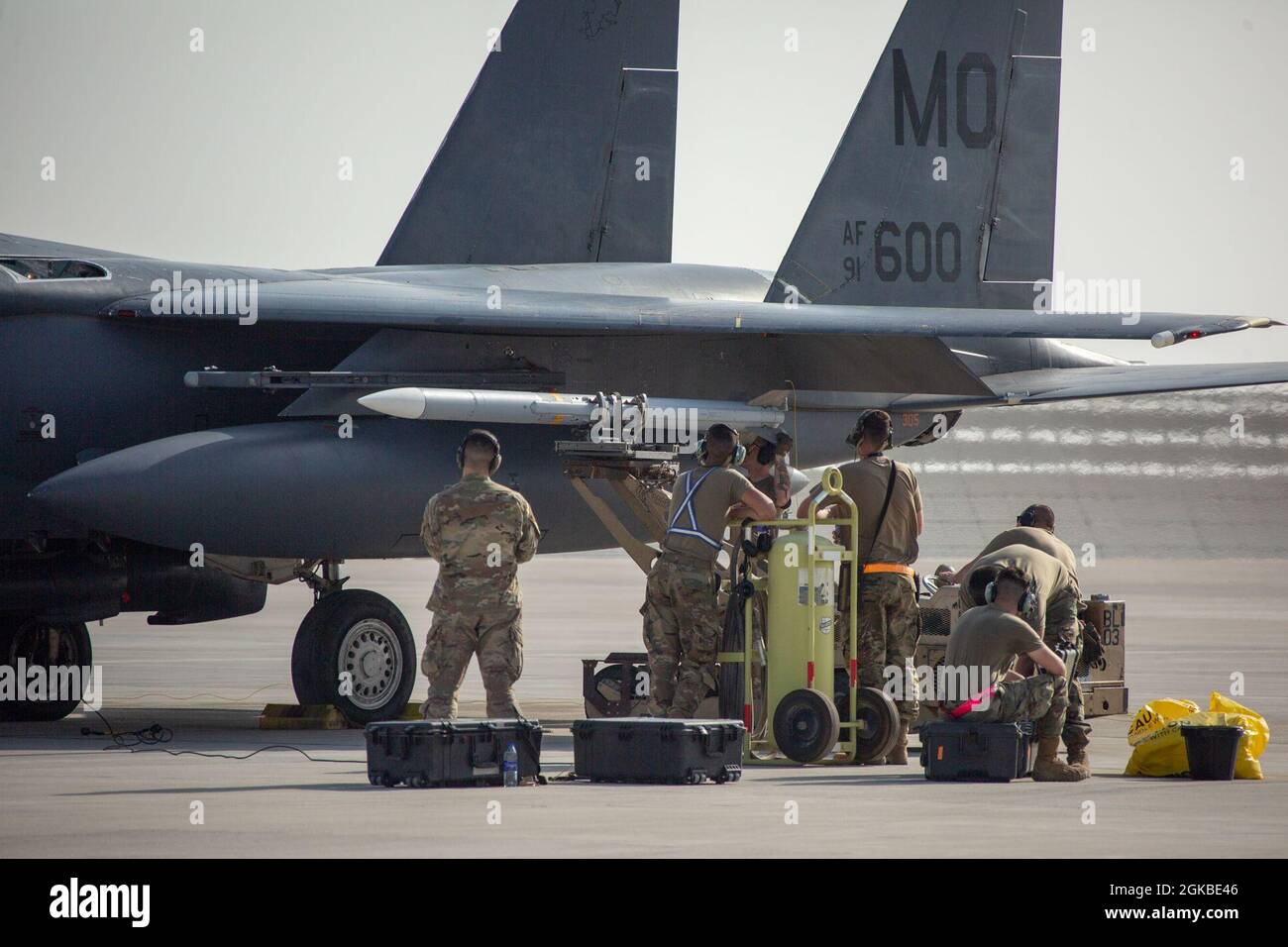 U.S. Airmen with the 332nd Air Expeditionary Wing load an AIM-120 ...