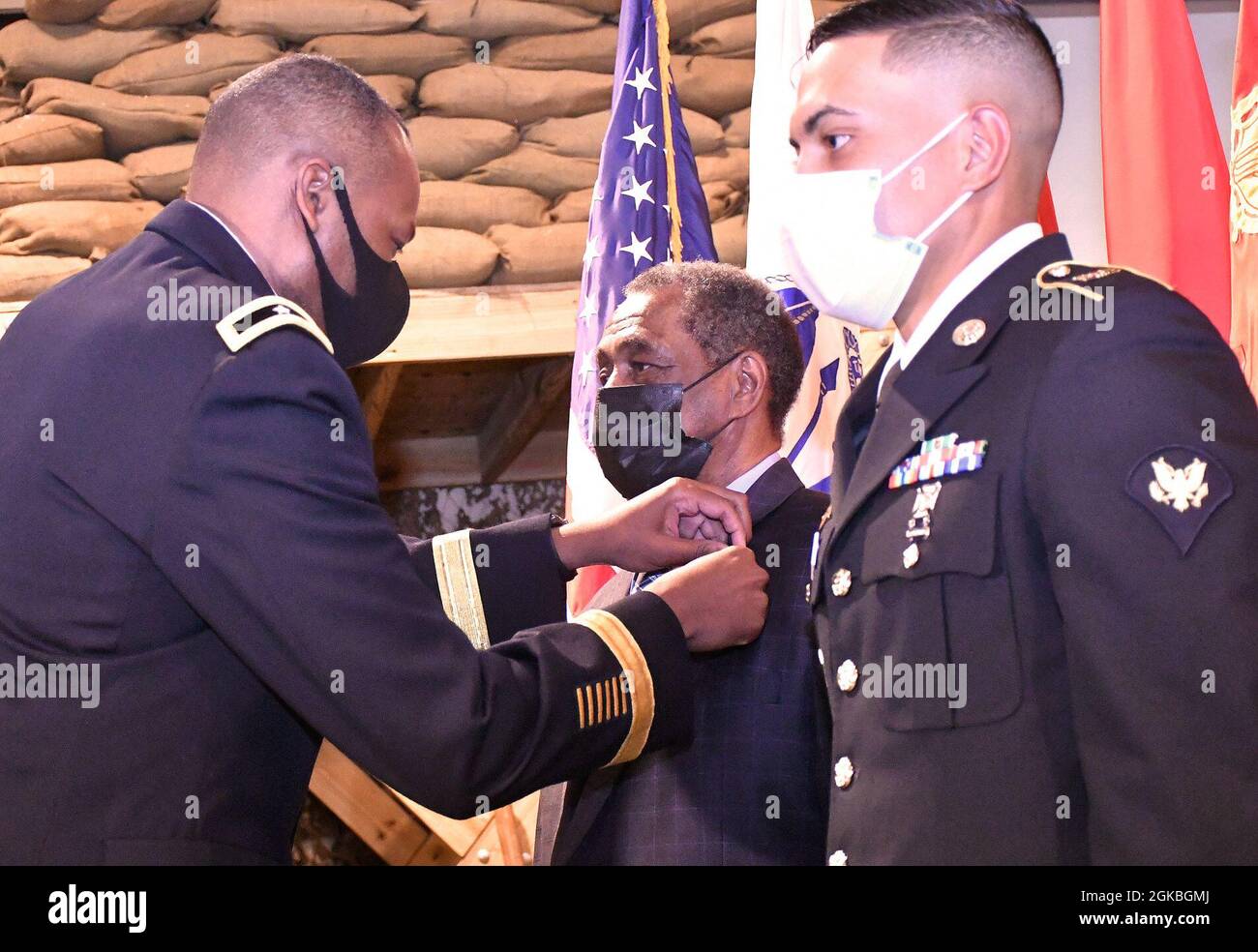 Brig. Gen. James M. Smith, Chief of Transportation, pins the Bronze Star Medal with “V” device ...