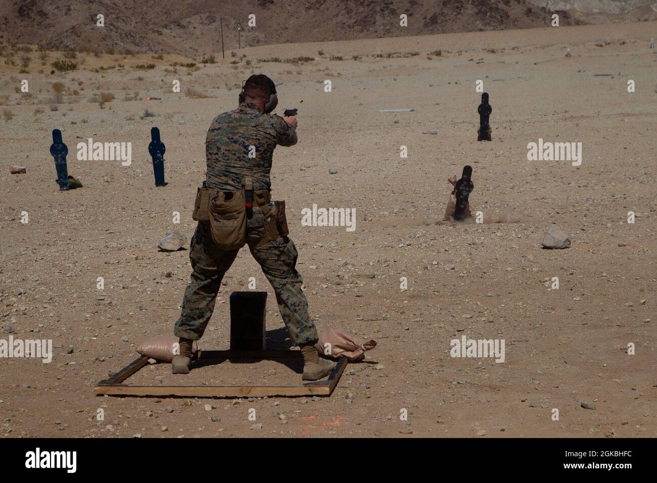 A U.S. Marine hits a target during the pistol competition in the Marine ...