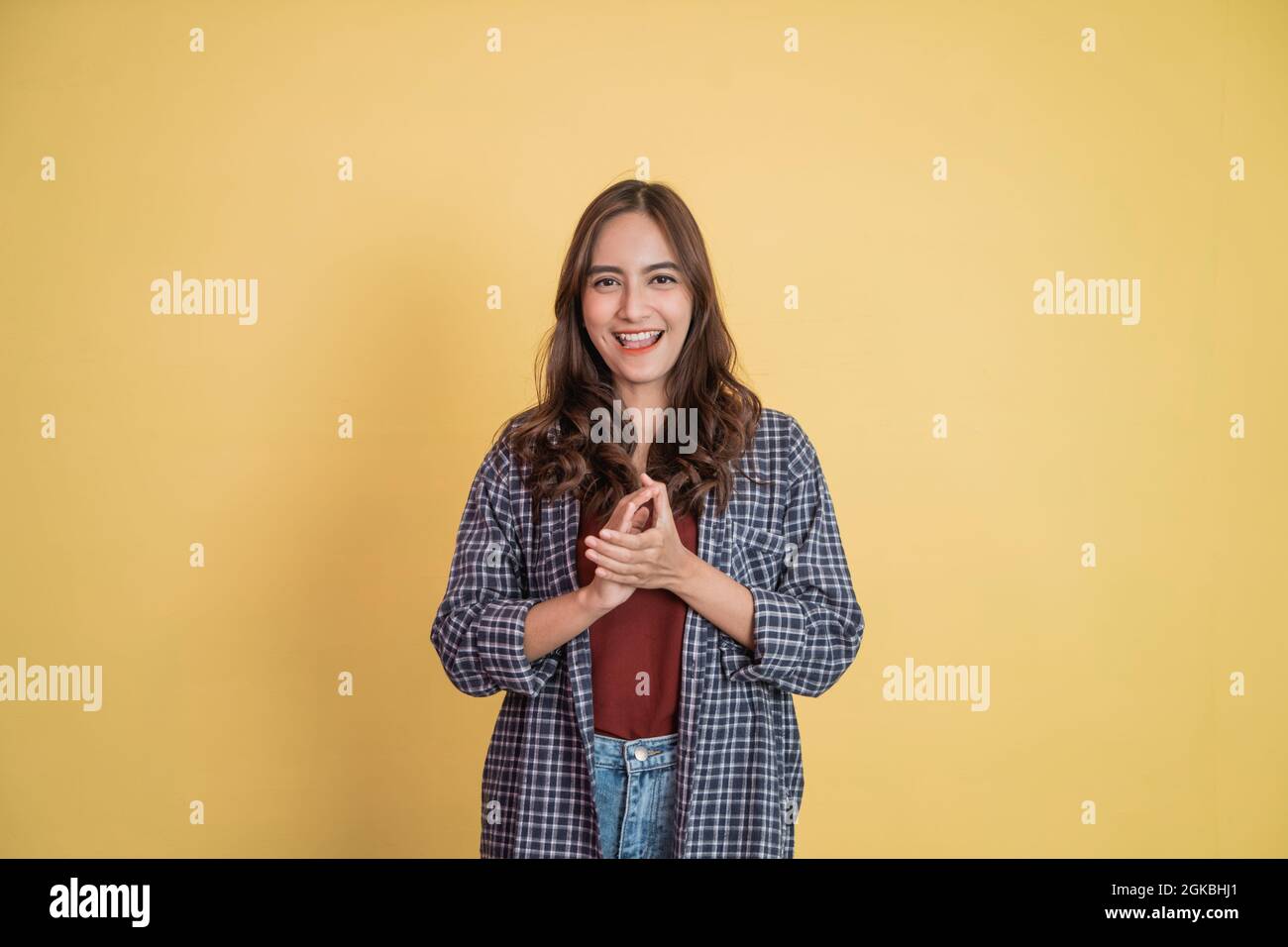 beautiful asian woman smiling while clapping when looking at camera ...