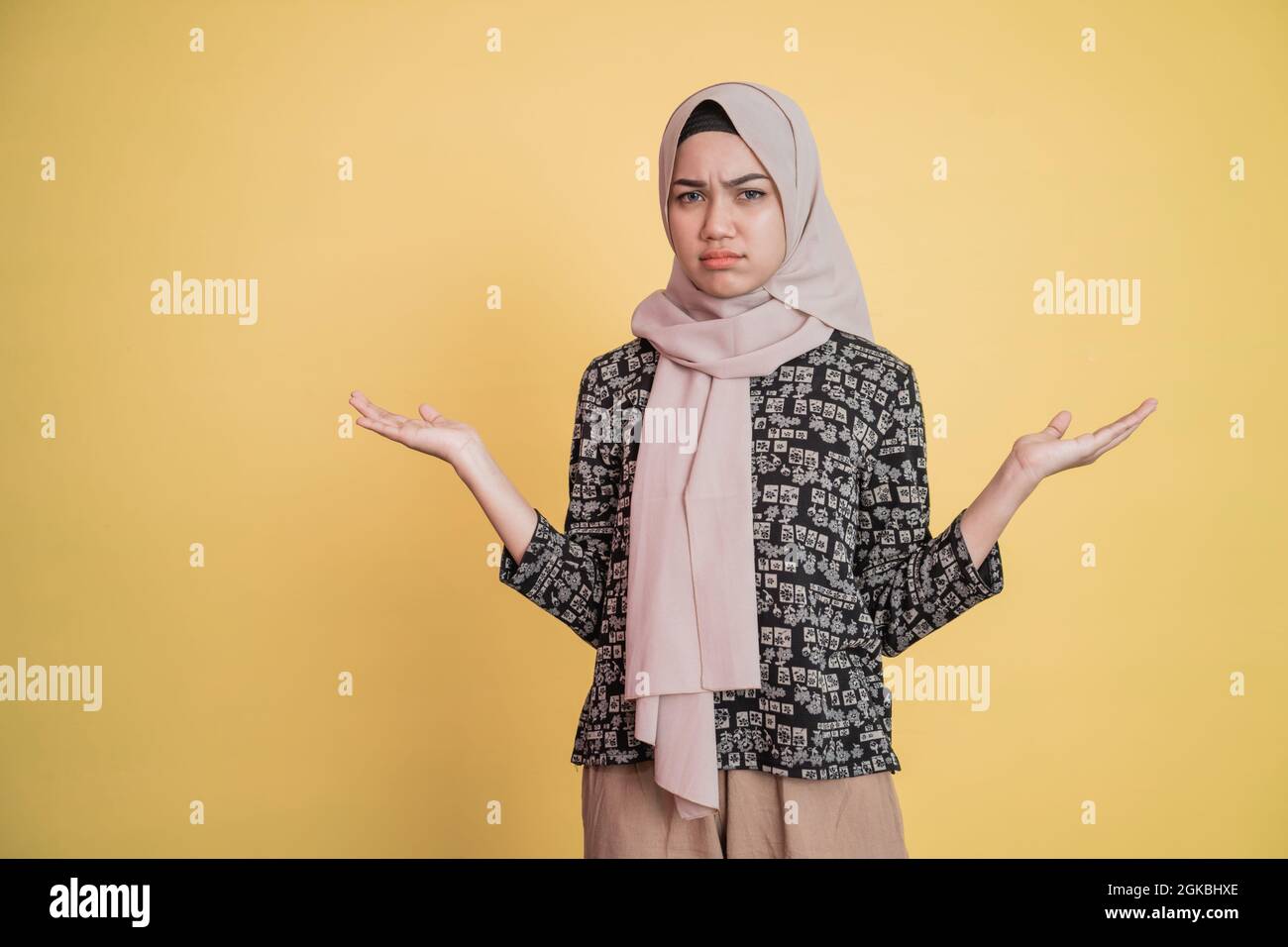 Muslim woman with sullen facial expression and sideways hand gesture ...