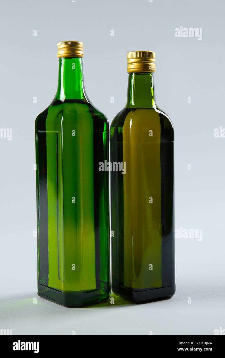 Bottles of cooking oil on light background Stock Photo - Alamy